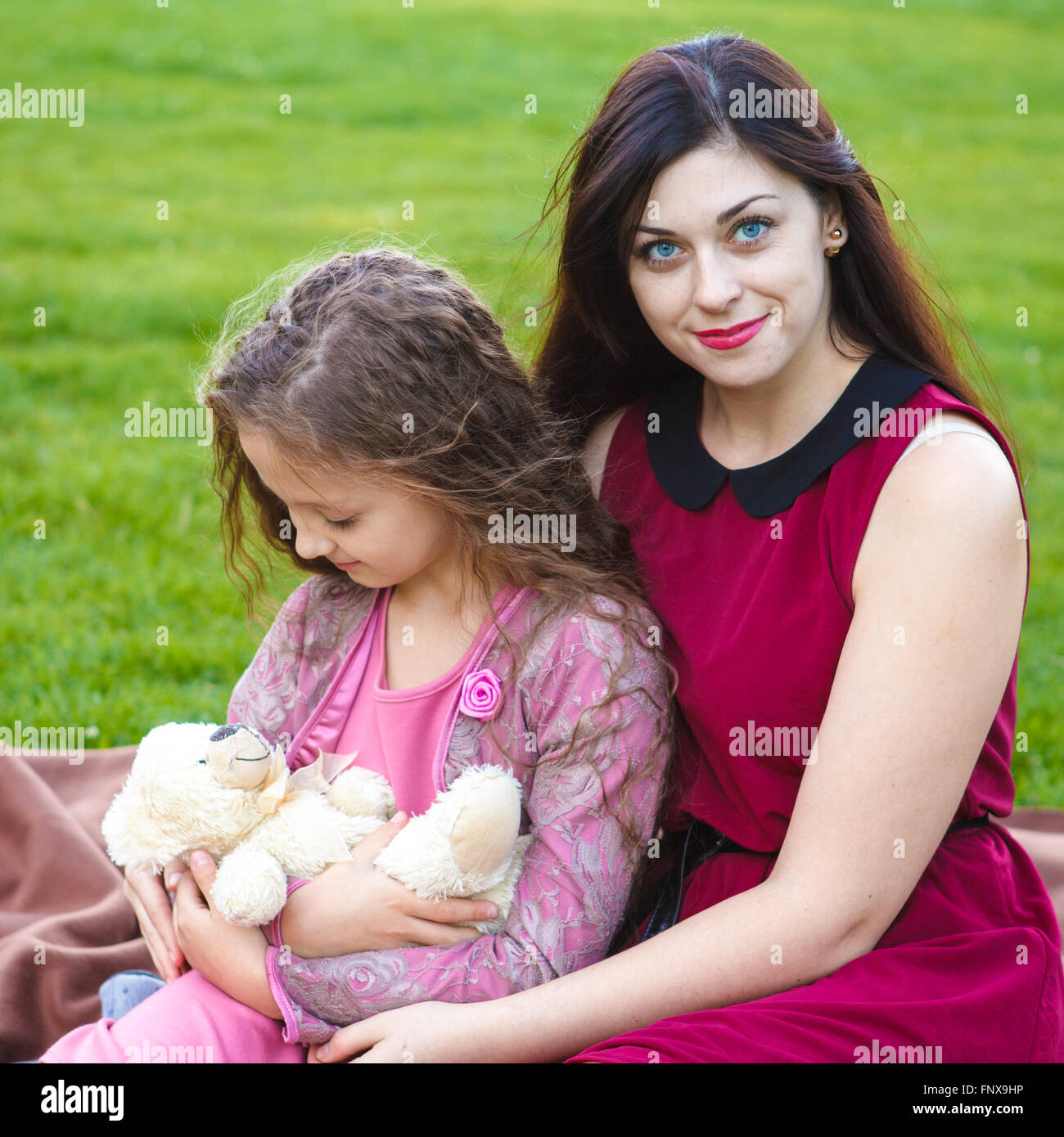 Mother hugs daughter in the park Stock Photo - Alamy