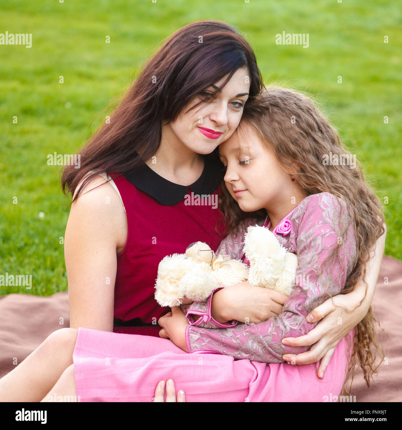 Mother hugs daughter in the park Stock Photo - Alamy