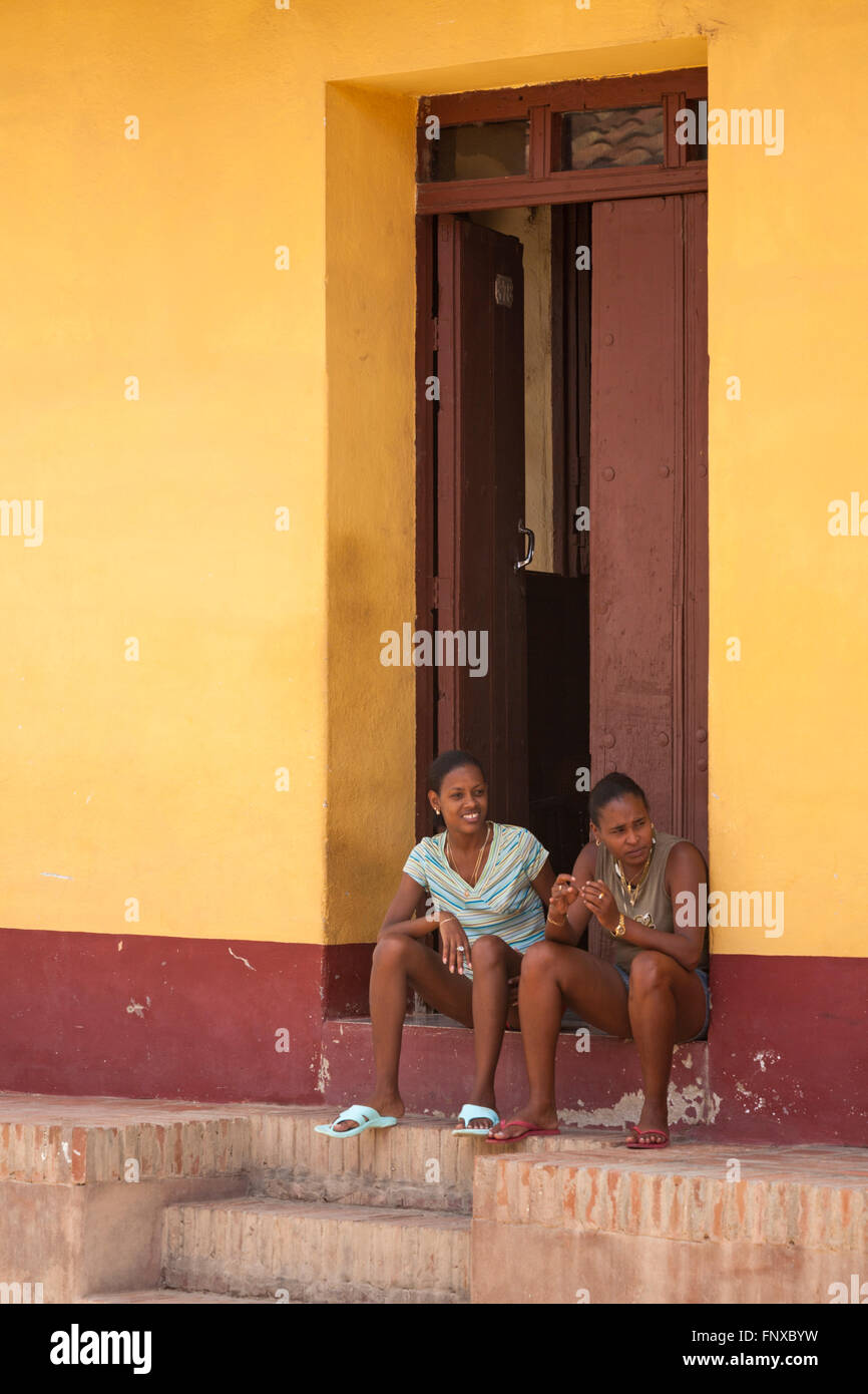 Daily life in Cuba - two women sat on steps at Trinidad, Cuba, West ...
