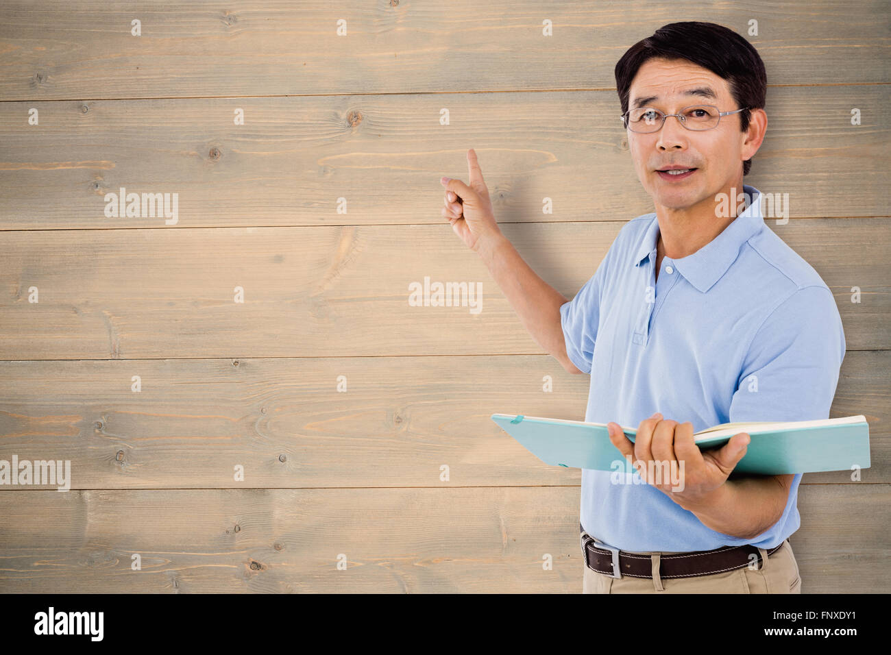 Composite image of elderly man pointing behind him Stock Photo - Alamy