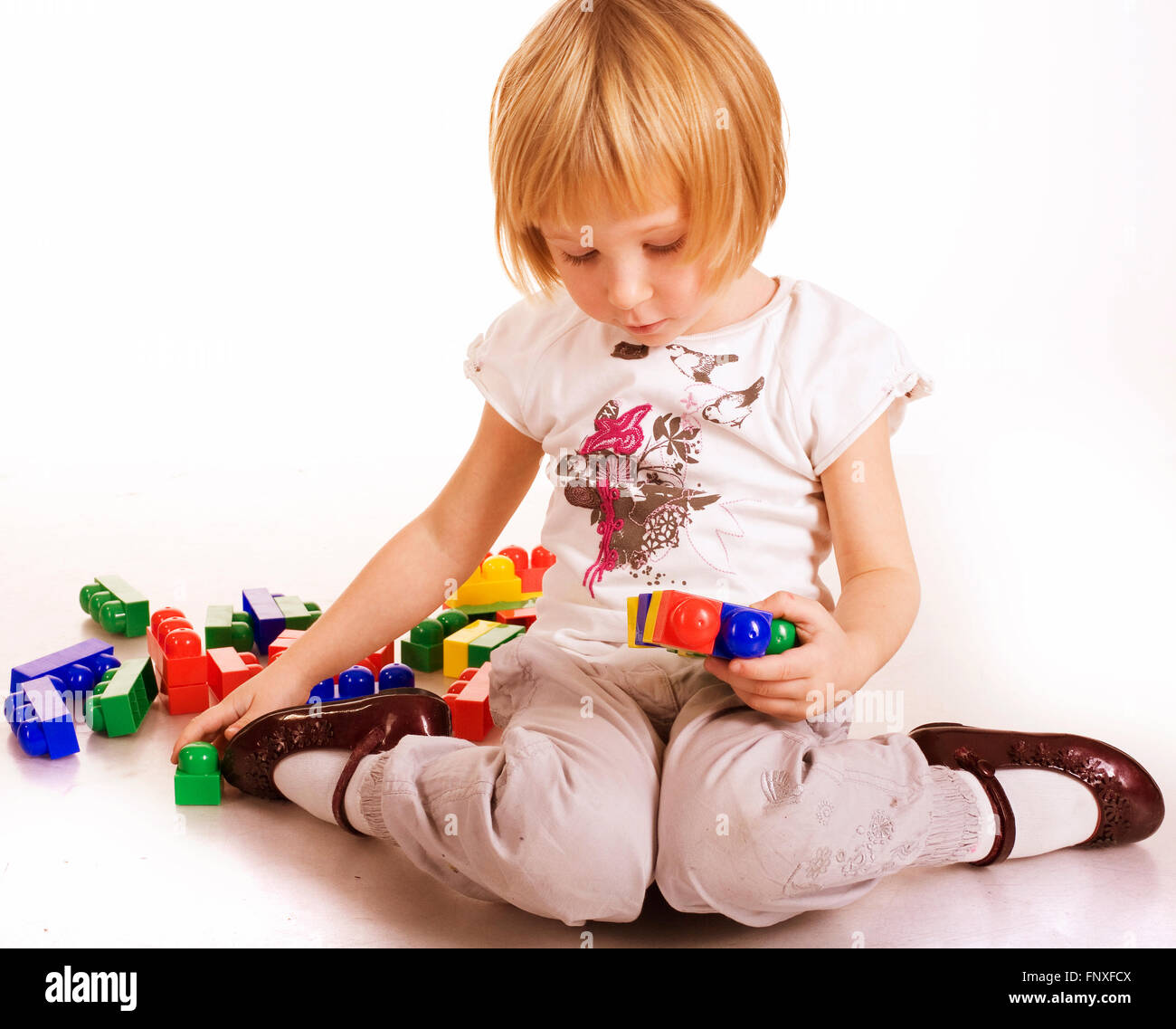 portrait of little cute girl painting and playing, fooling around ...
