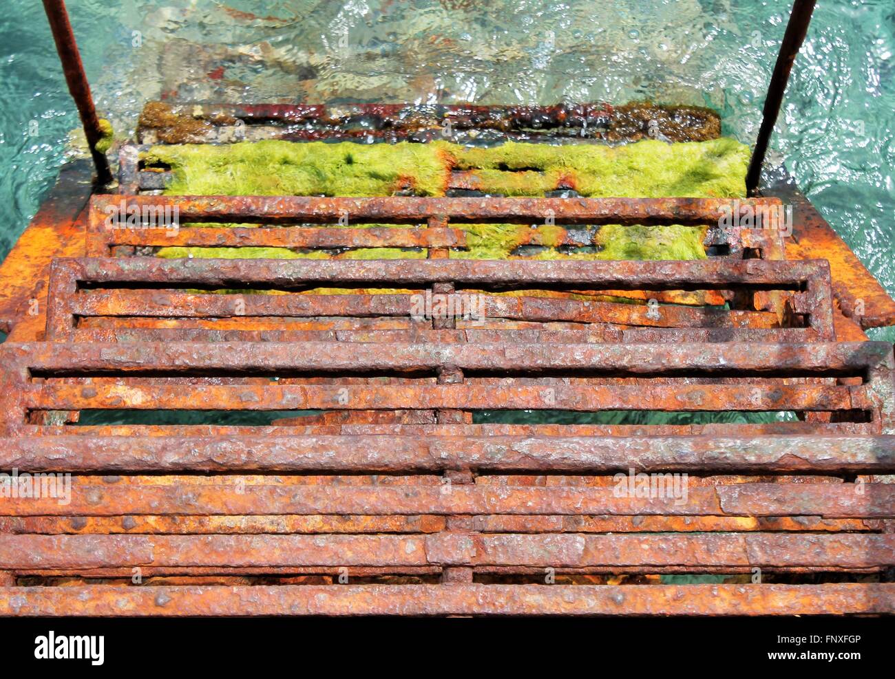 rusty steps of stairs into ocean sea on greek island Stock Photo - Alamy