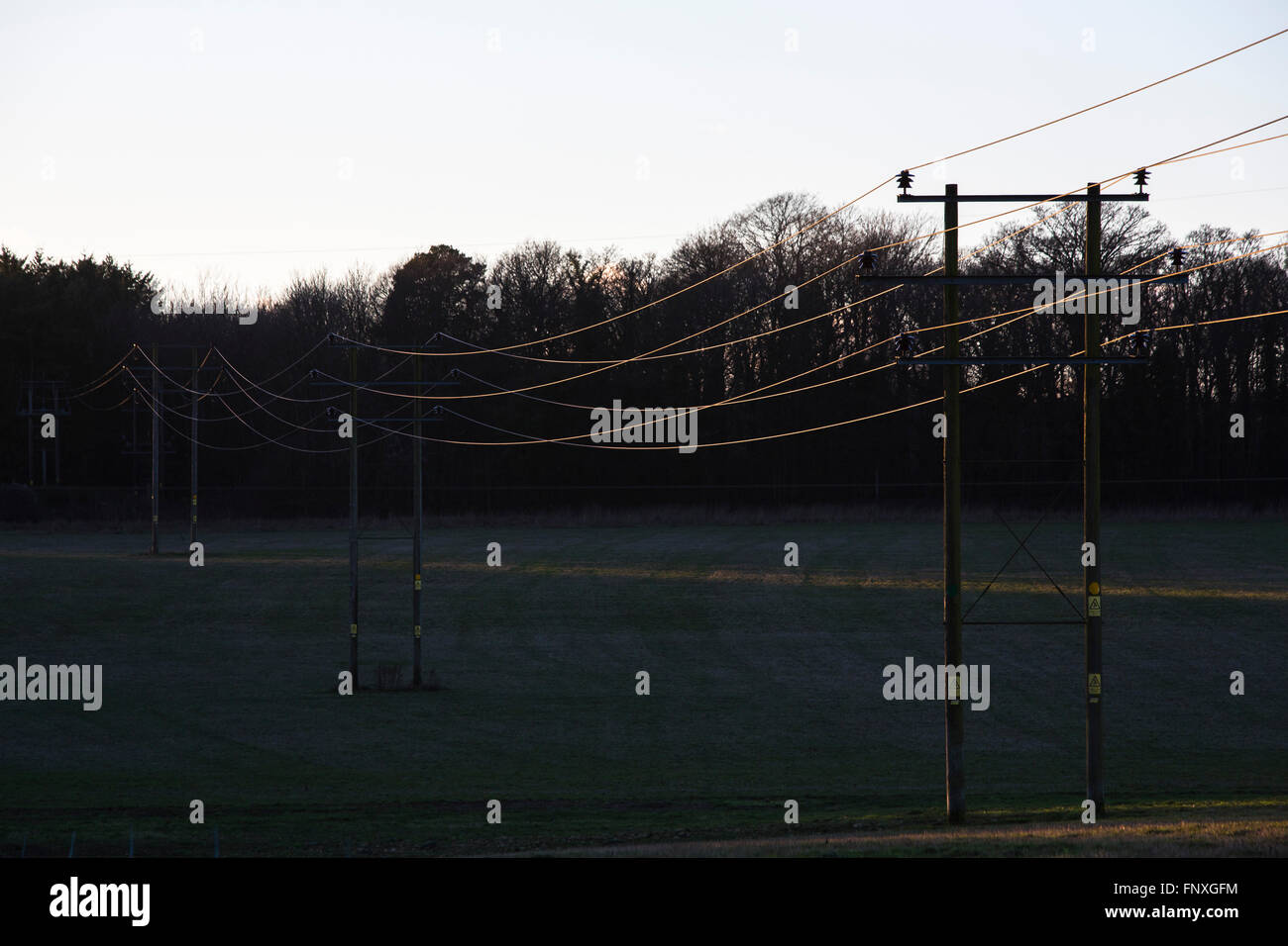 Electrical power lines in the colouring sky as the sunsets Stock Photo ...