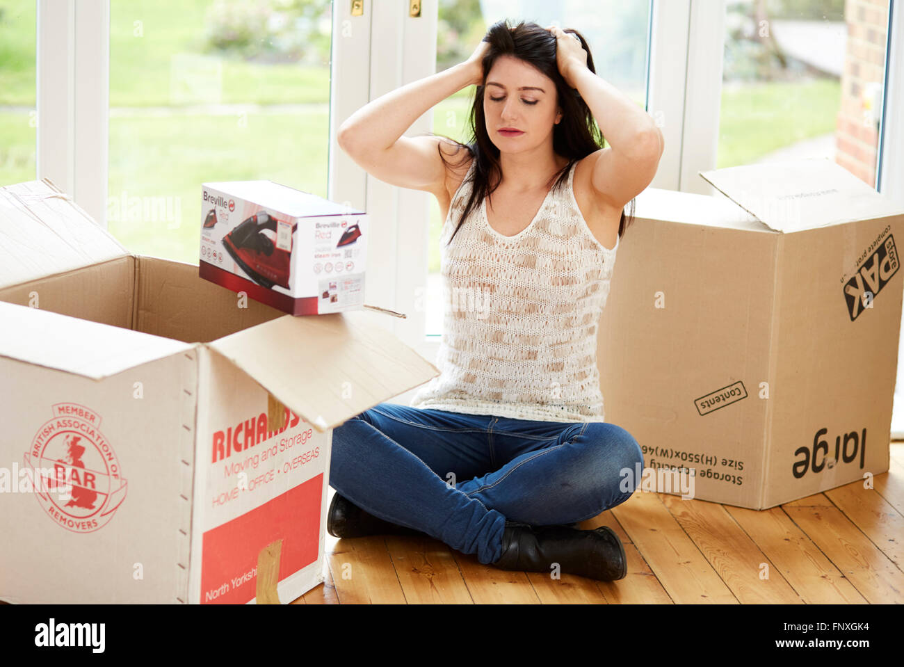 Woman moving house Stock Photo - Alamy