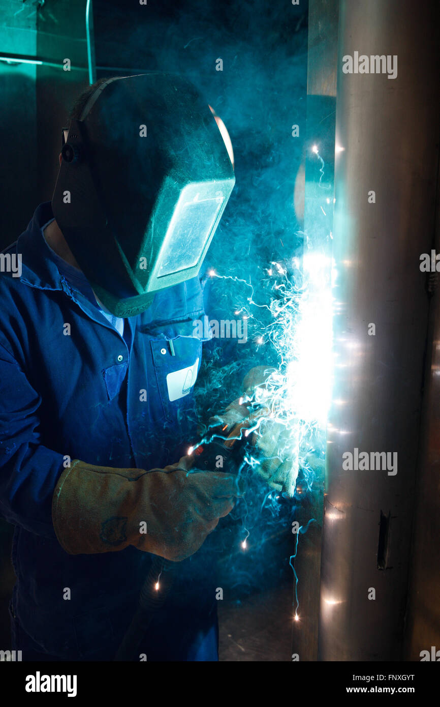 an engineer welding in a work environment with a welding torch Stock ...