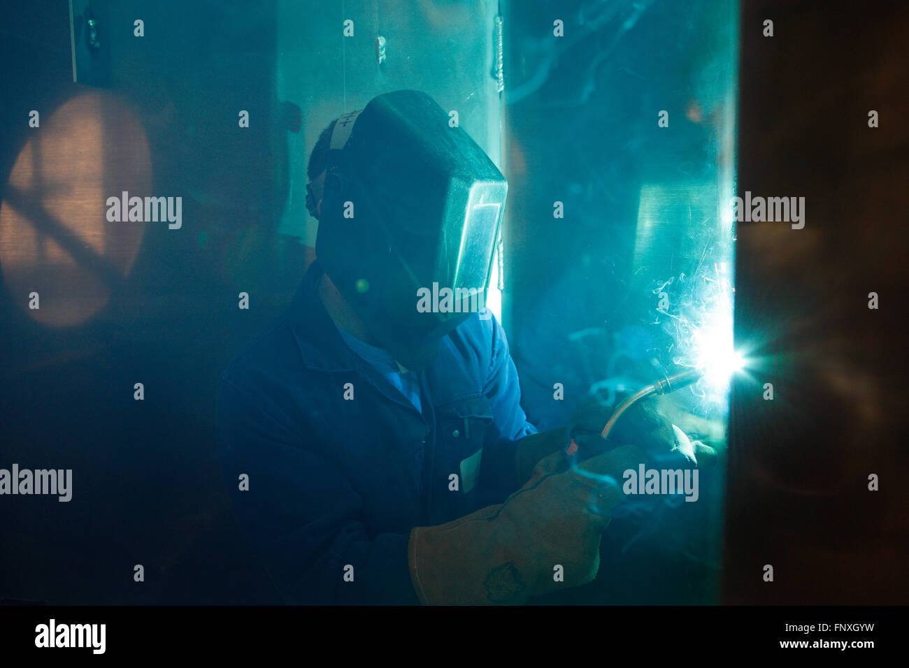 an engineer welding in a work environment with a welding torch Stock ...