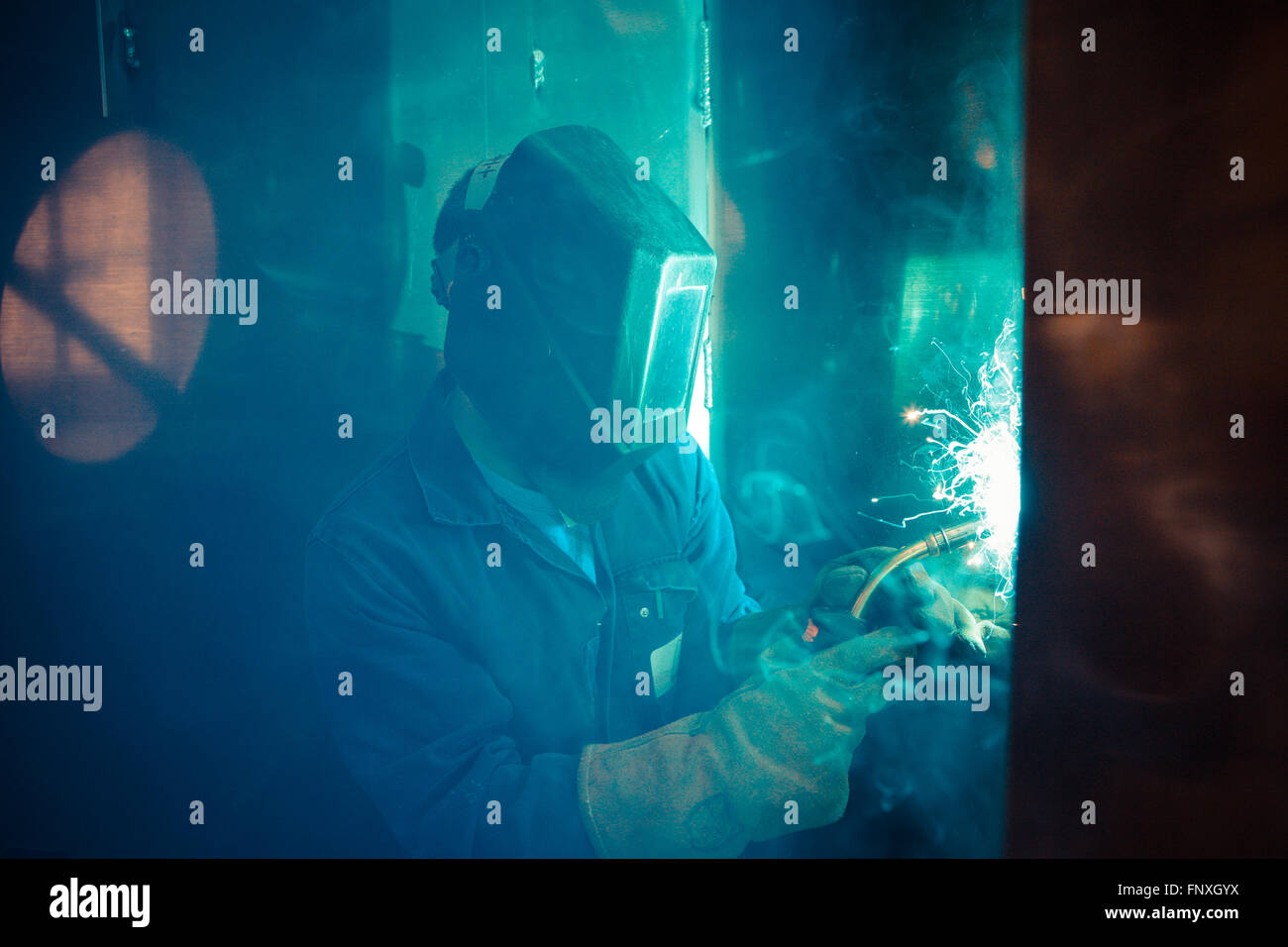 an engineer welding in a work environment with a welding torch Stock ...