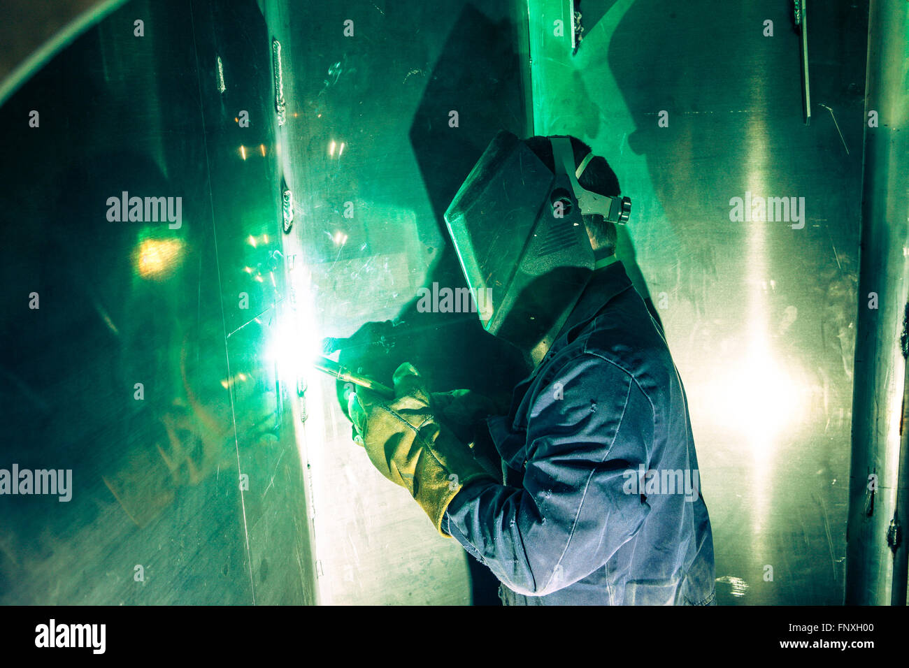 an engineer welding in a work environment with a welding torch Stock ...