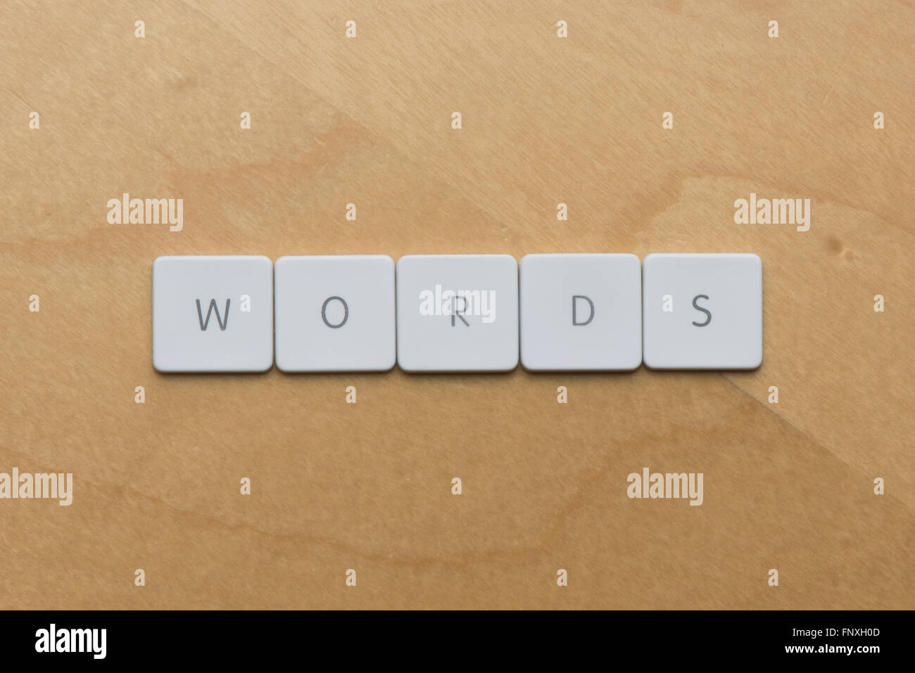 Keyboard letters spell words on a desk background Stock Photo - Alamy
