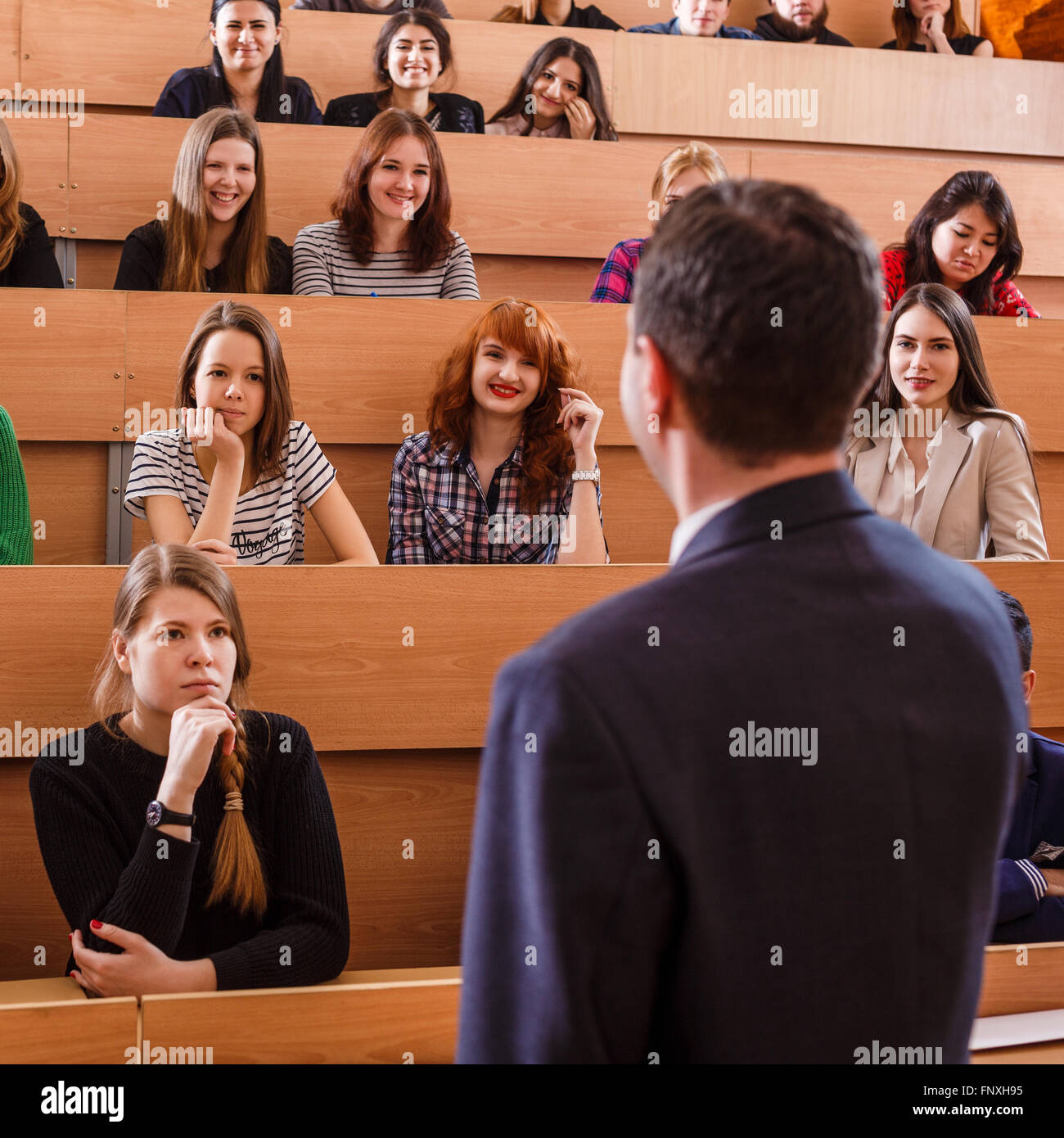 Teacher explaining something to students Stock Photo - Alamy
