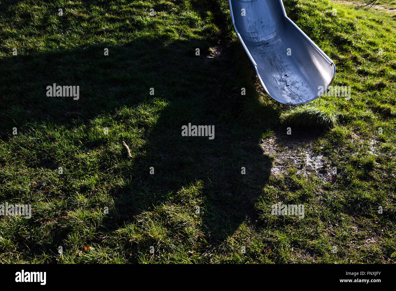 A childrens slide in a UK park, made from bright silver metal Stock ...
