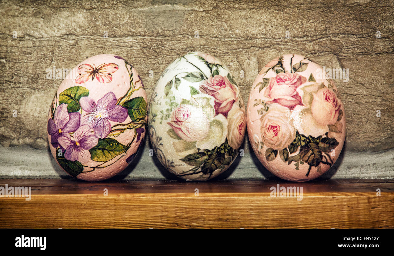 Three Easter eggs stacked on the wooden base. Easter holiday. Symbol of ...