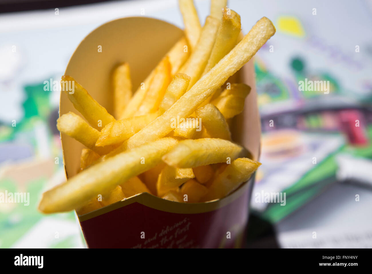A pack of take away chips in cardboard carton from a Mc donalds ...