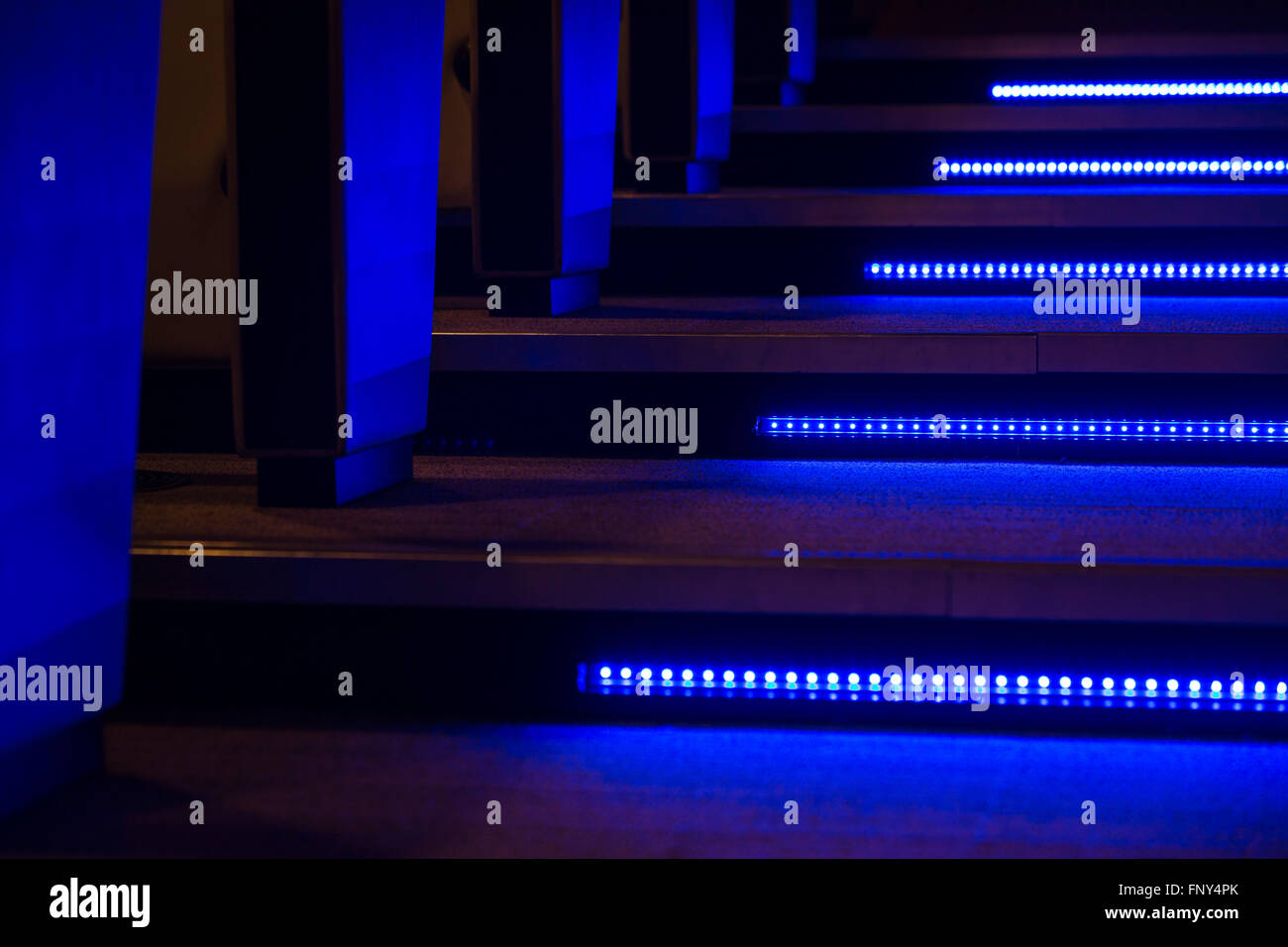 Steps in an office conference room lit by blue strip lighting to pick ...