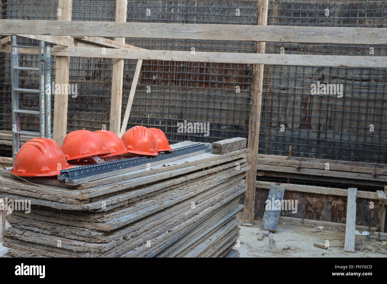 Helmets on construction site Stock Photo - Alamy