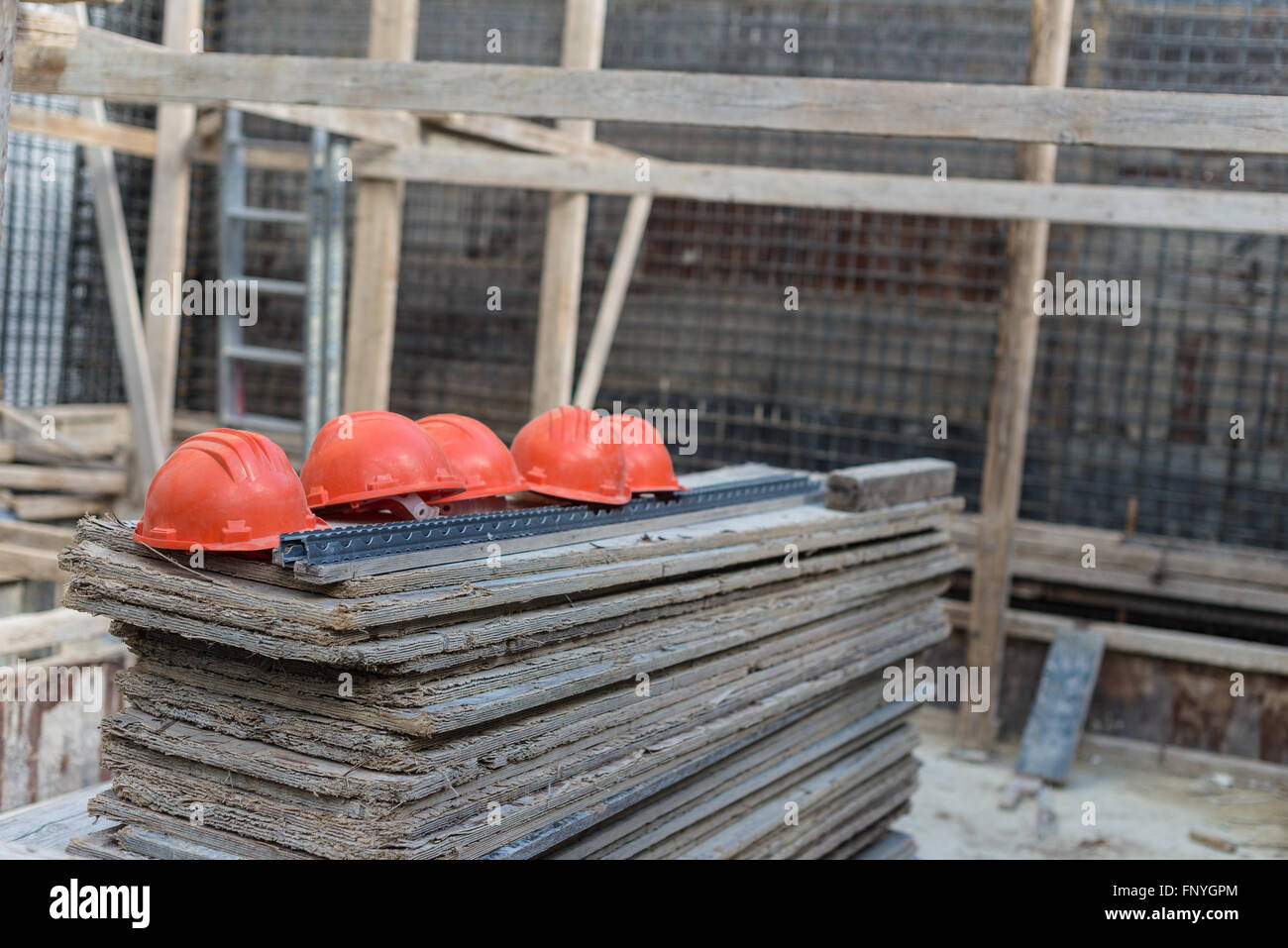 Helmets on construction site Stock Photo - Alamy