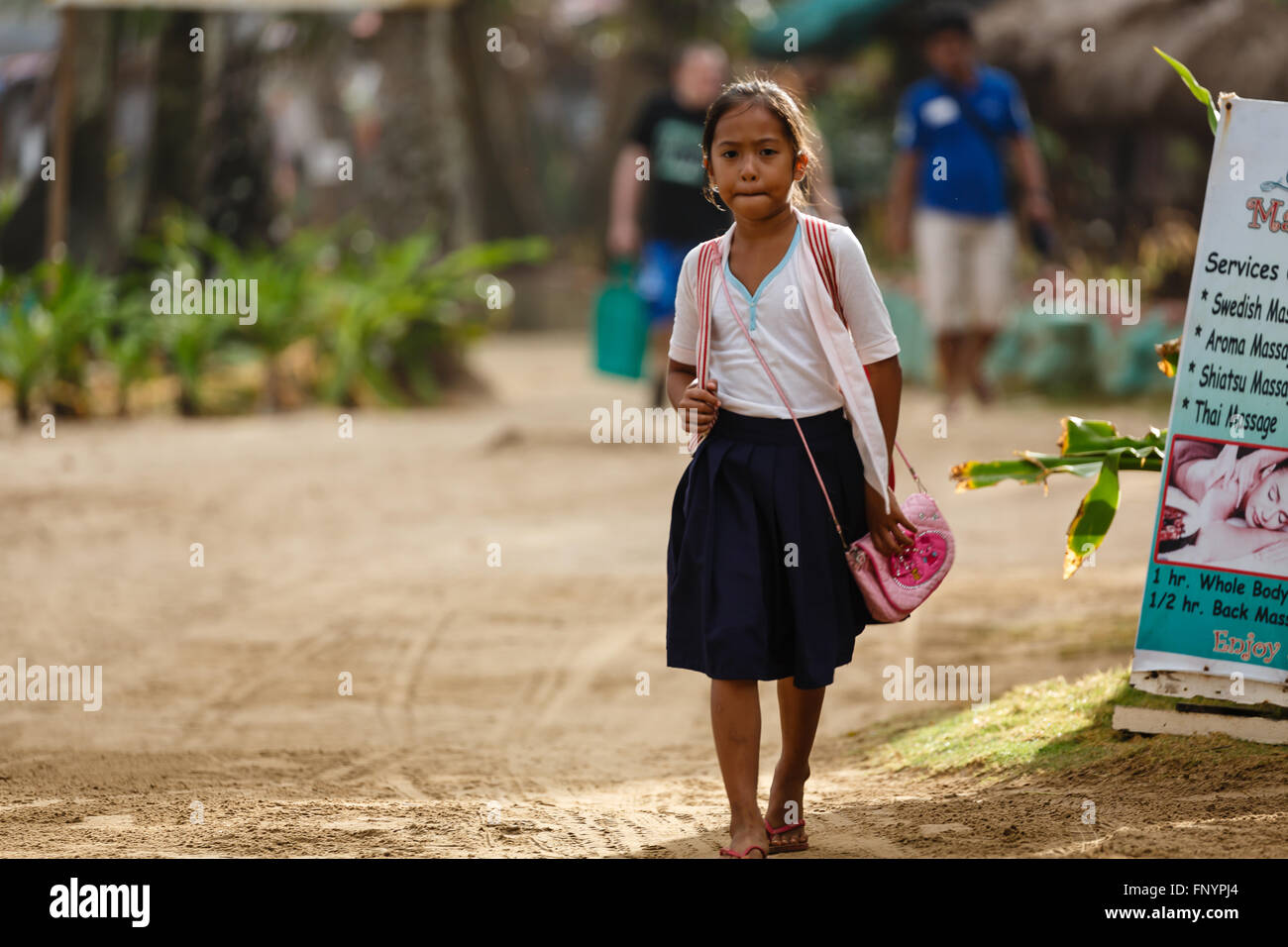 Close up of native girl walking on village street in Leyte Island ...
