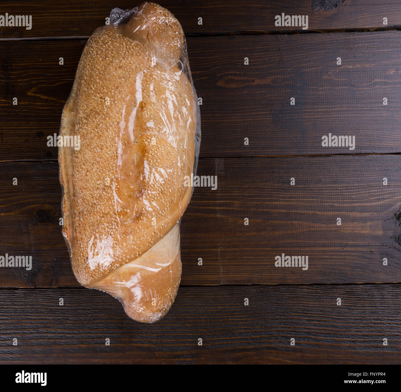 Single loaf of bread with sesame seeds on loaf in plastic shrink wrap ...