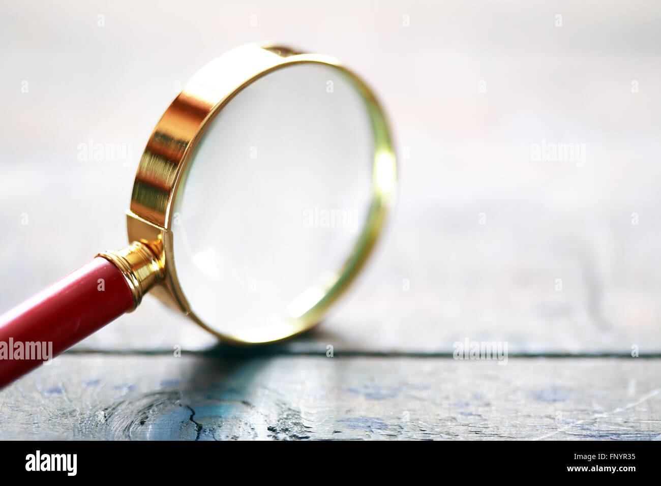 Investigation concept. Magnifying glass closeup on wooden surface Stock ...
