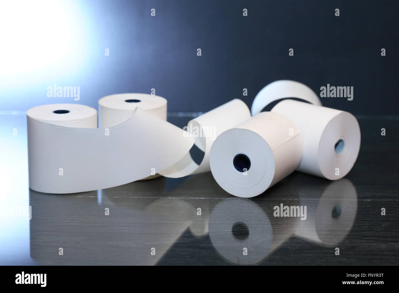 White paper rolls with reflection on dark background Stock Photo - Alamy