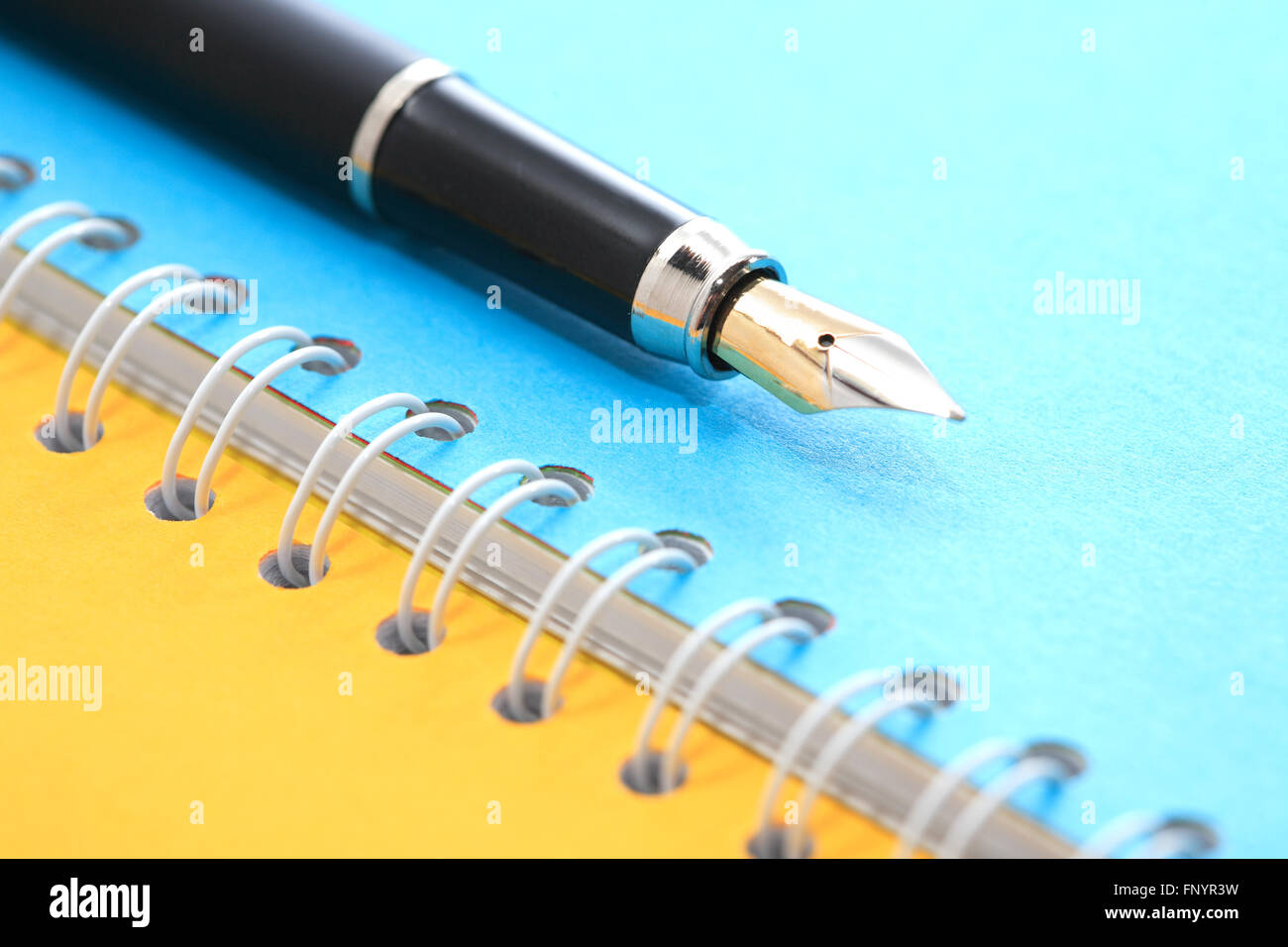 Stationery background. Fountain pen on notebook with colored blank ...