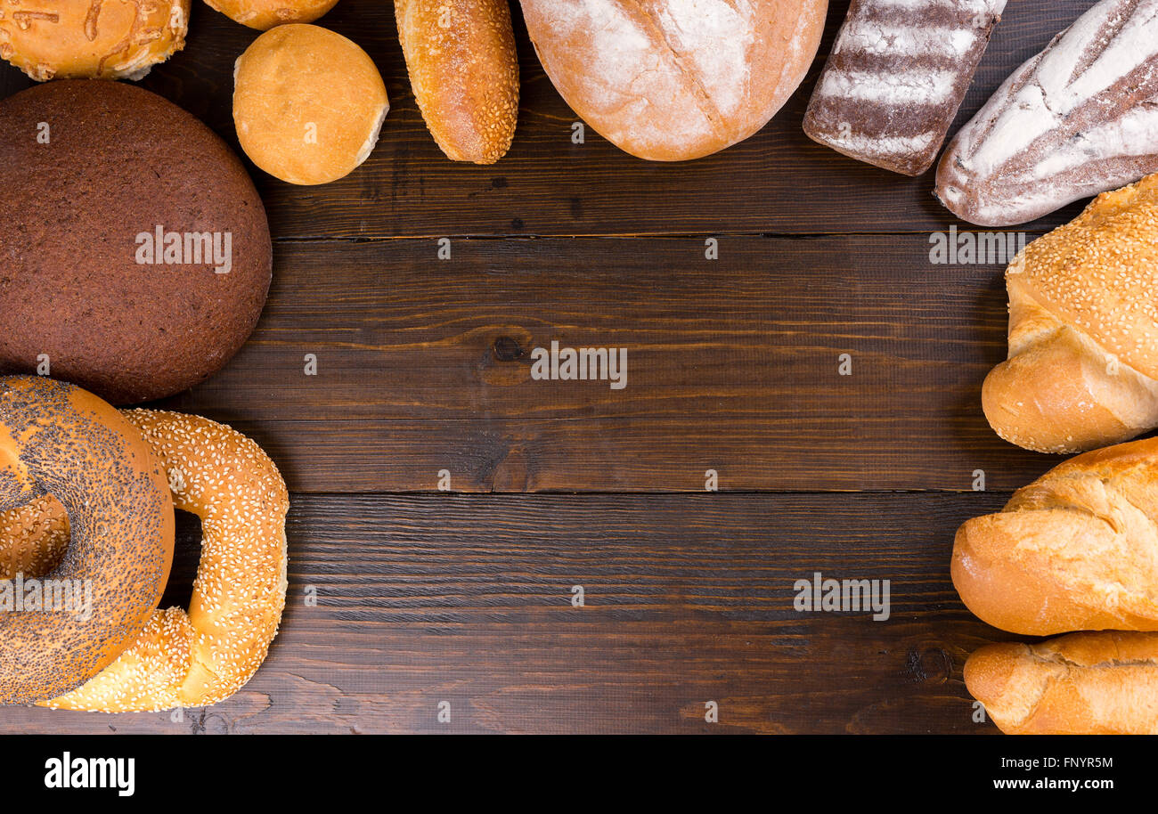 Top down view on dark wood paneled table with blank center surrounded ...