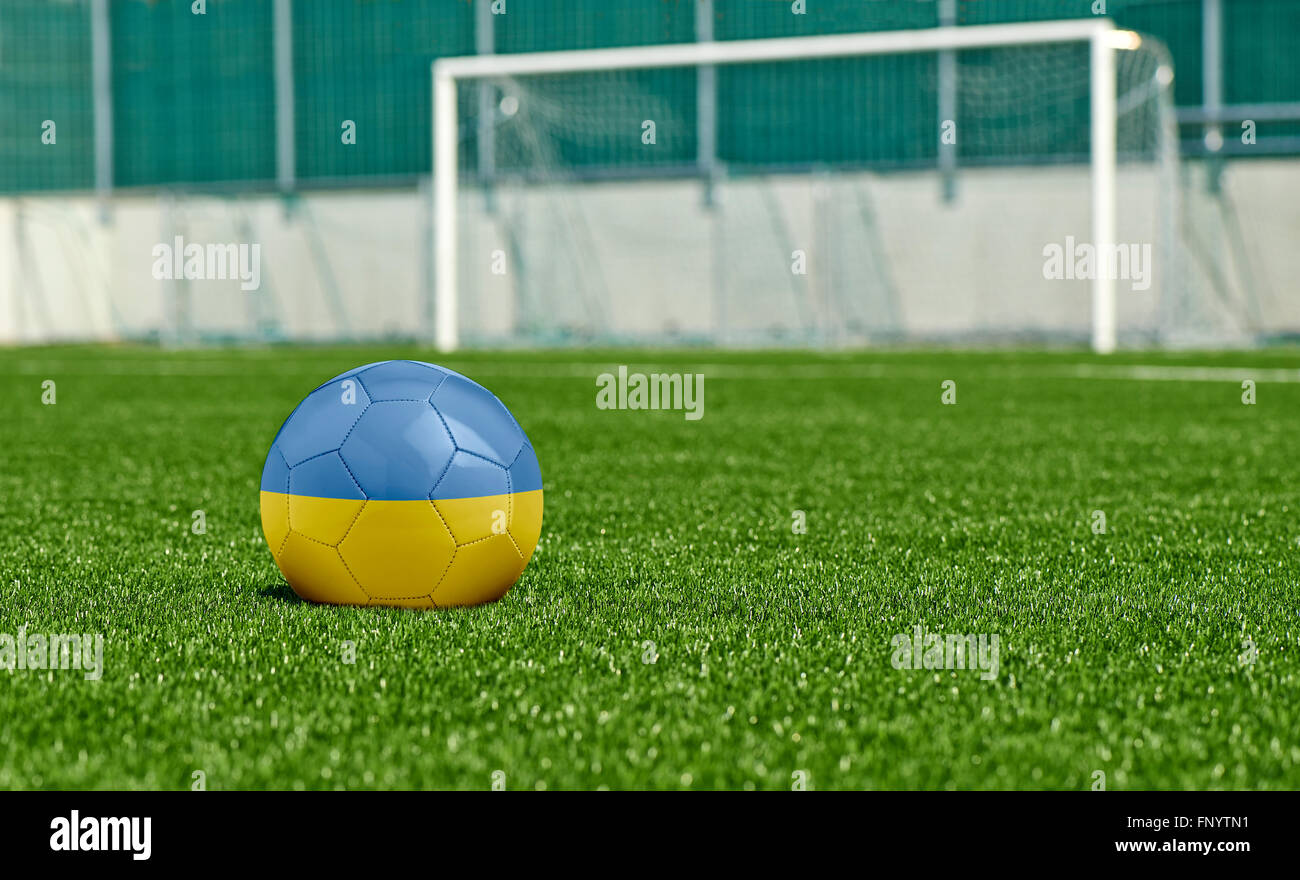 Soccer ball with the flag from Ukraine on the green field Stock Photo ...