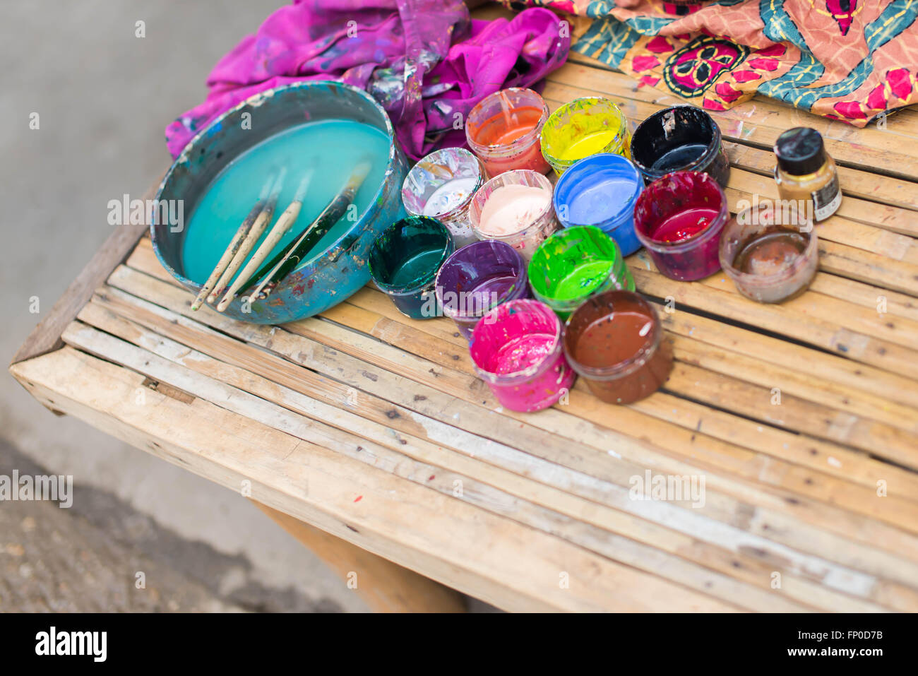 paint buckets on wood table background Stock Photo - Alamy