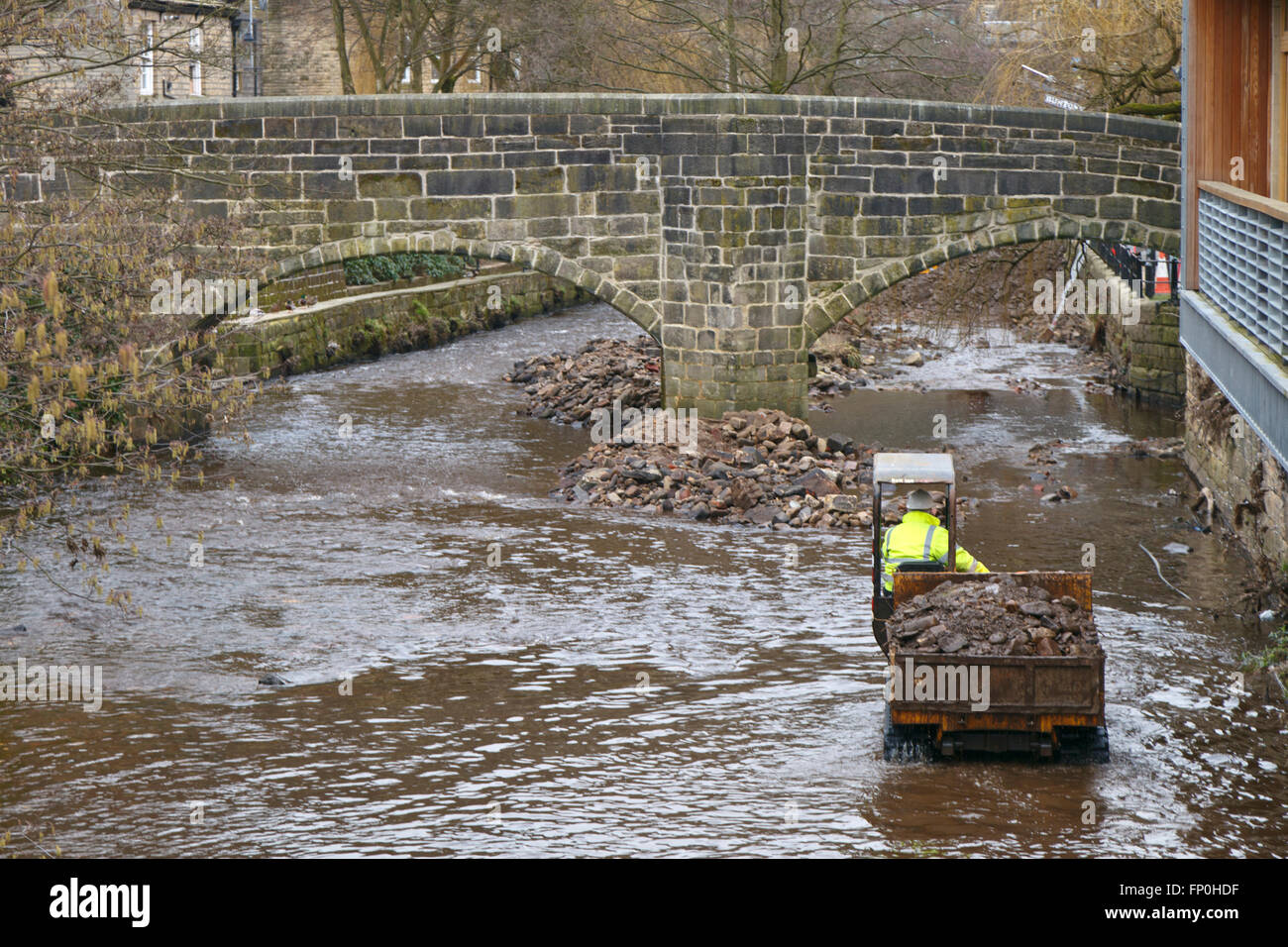 A small rubber track carrier hauls away rubble dredged out of Hebden ...