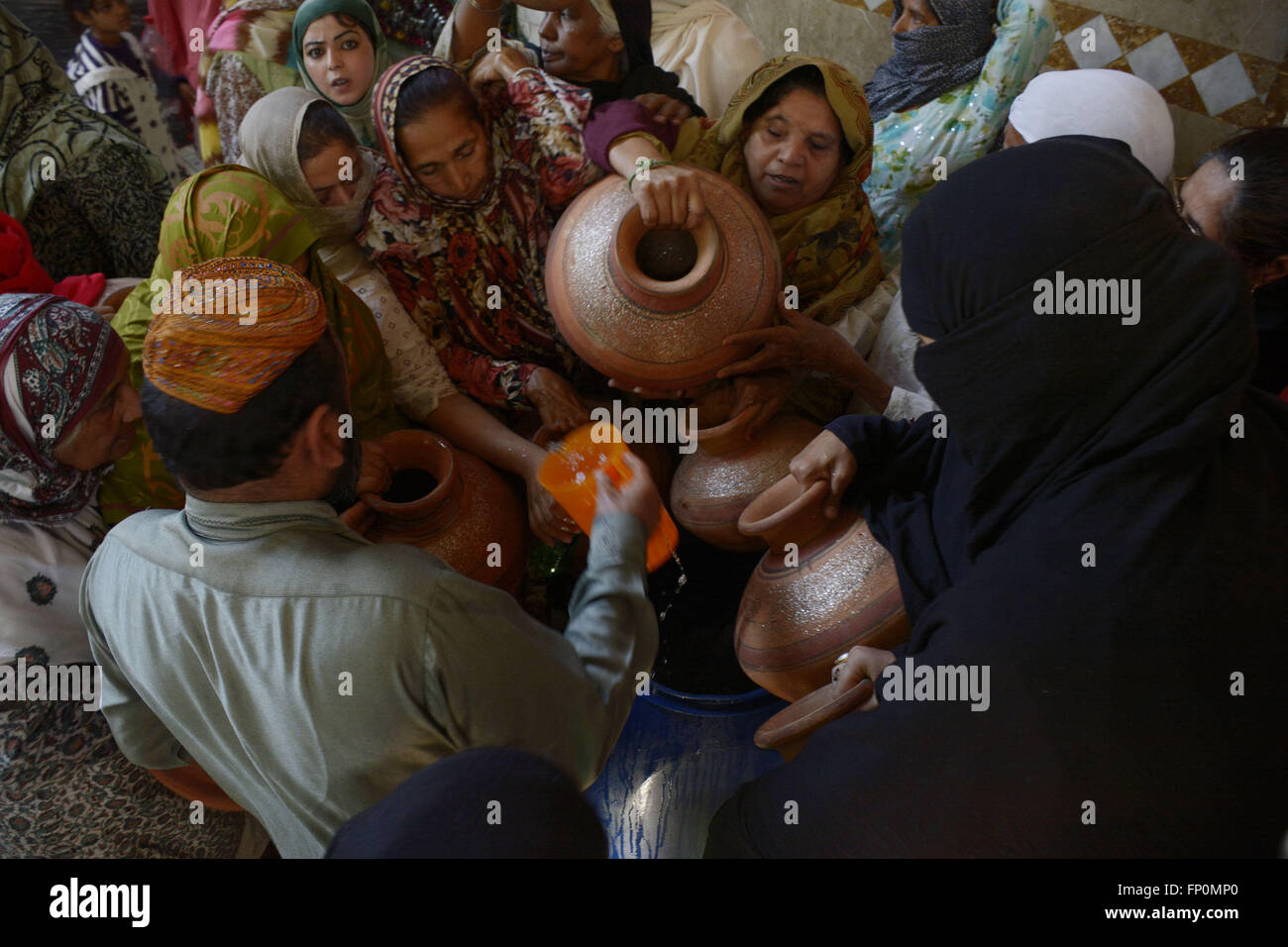 Lahore, Pakistan. 17th Mar, 2016. Pakistani women devotees bringing ...