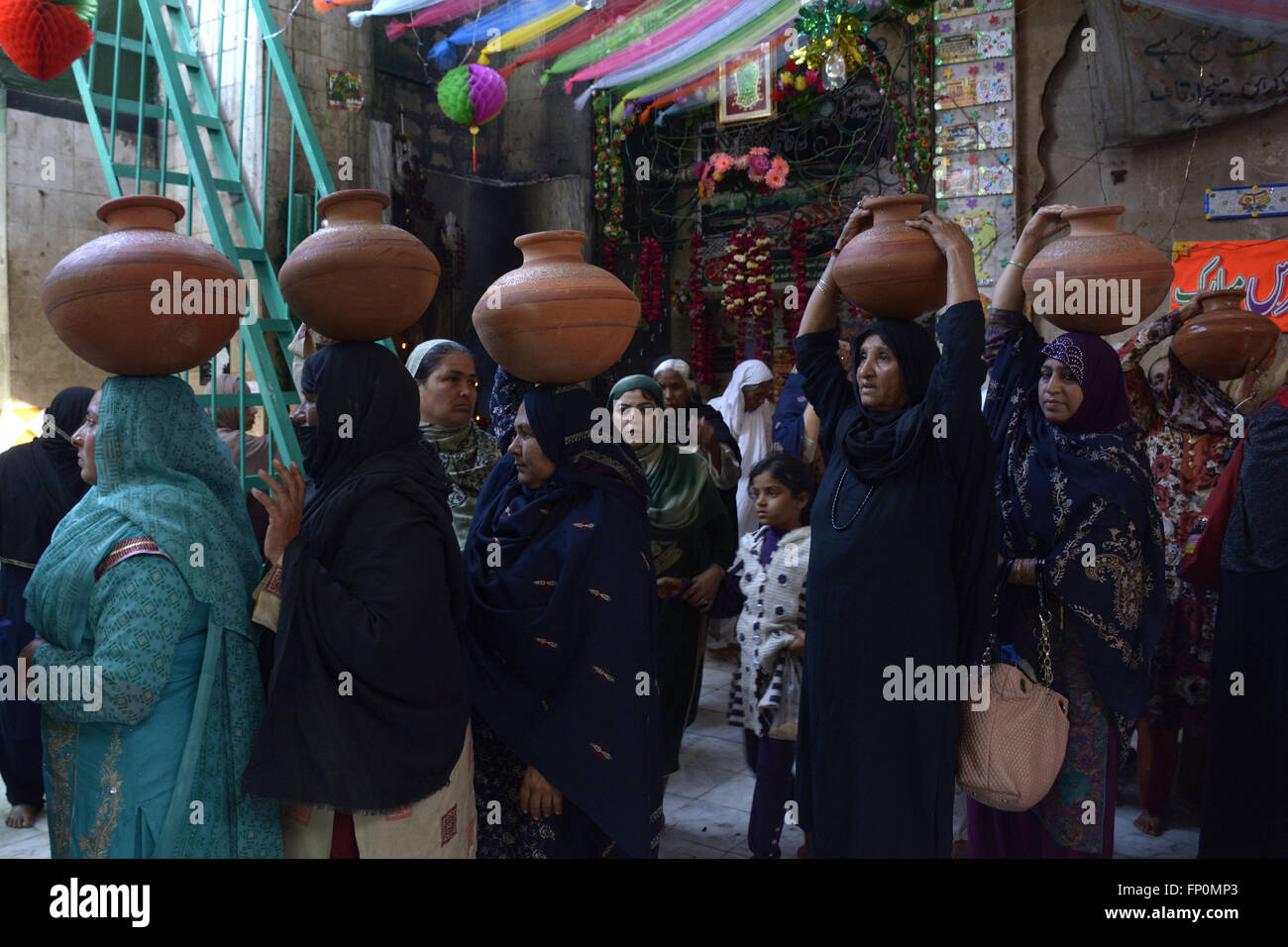 Lahore, Pakistan. 16th Mar, 2016. Pakistani women devotees bringing ...