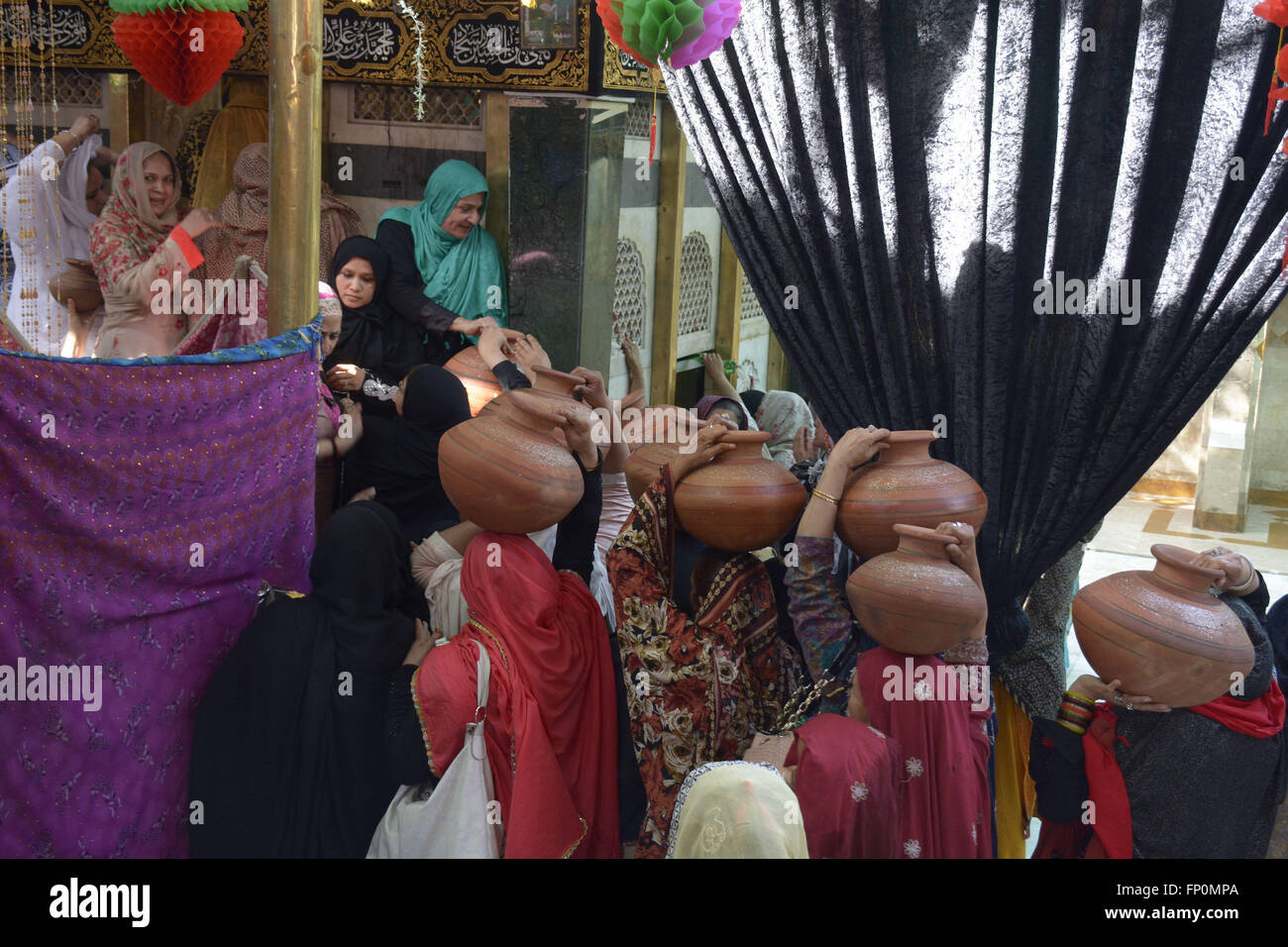 Lahore, Pakistan. 16th Mar, 2016. Pakistani women devotees bringing ...