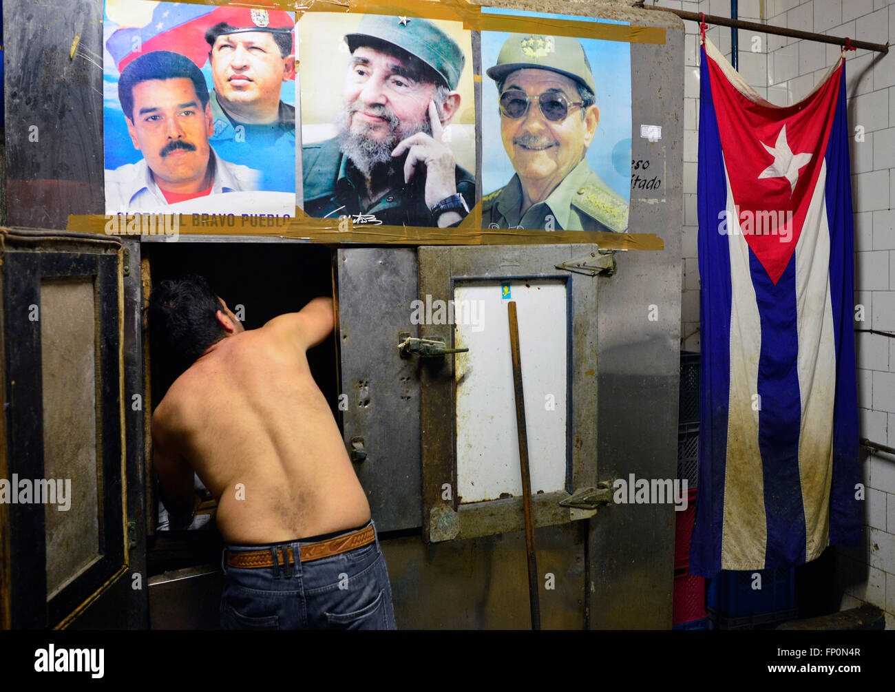 Havana, Cuba. 16th Mar, 2016. A man works in his shop, decorated with ...