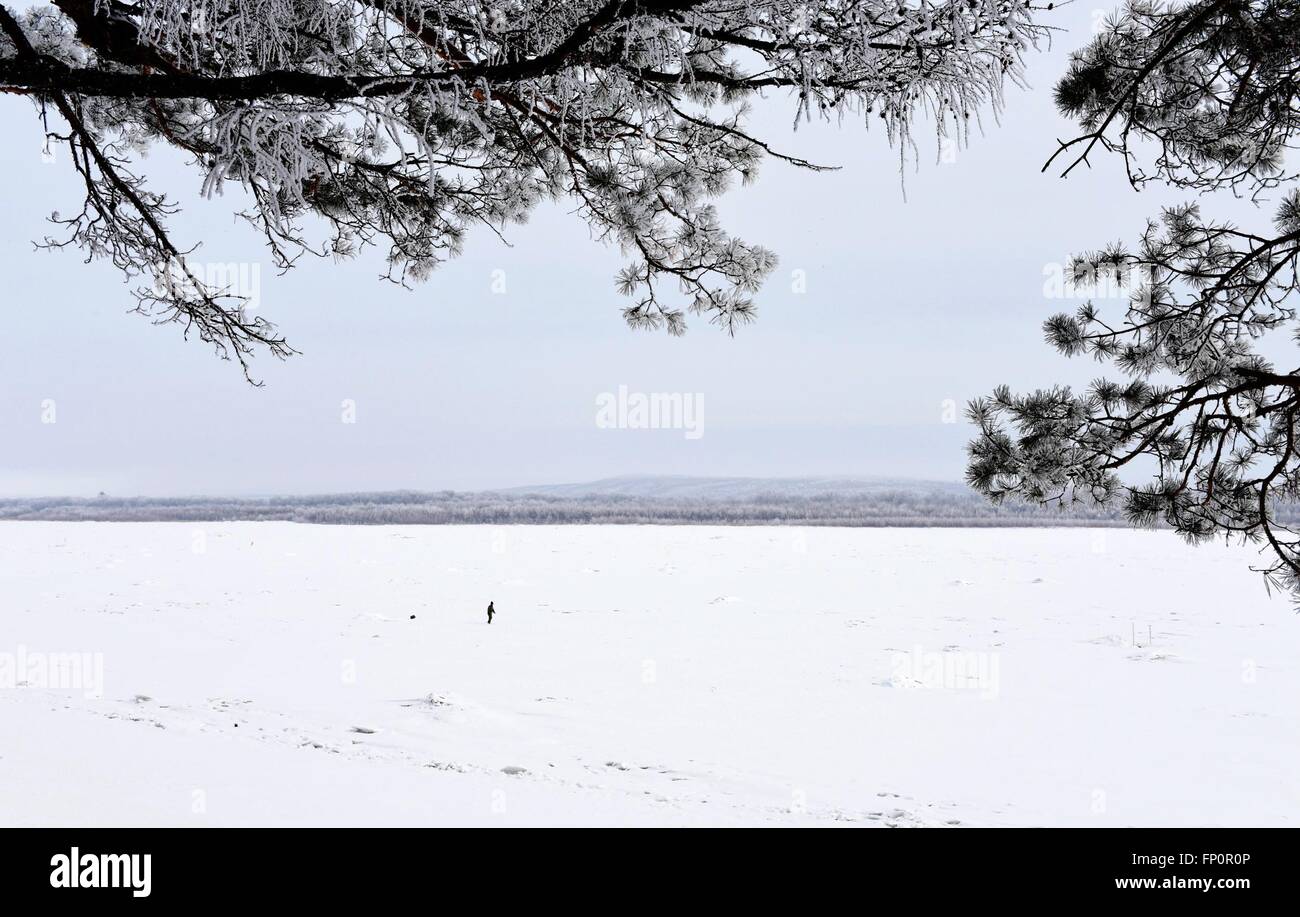 Huma, China's Heilongjiang Province. 17th Mar, 2016. A pedestrian walks ...