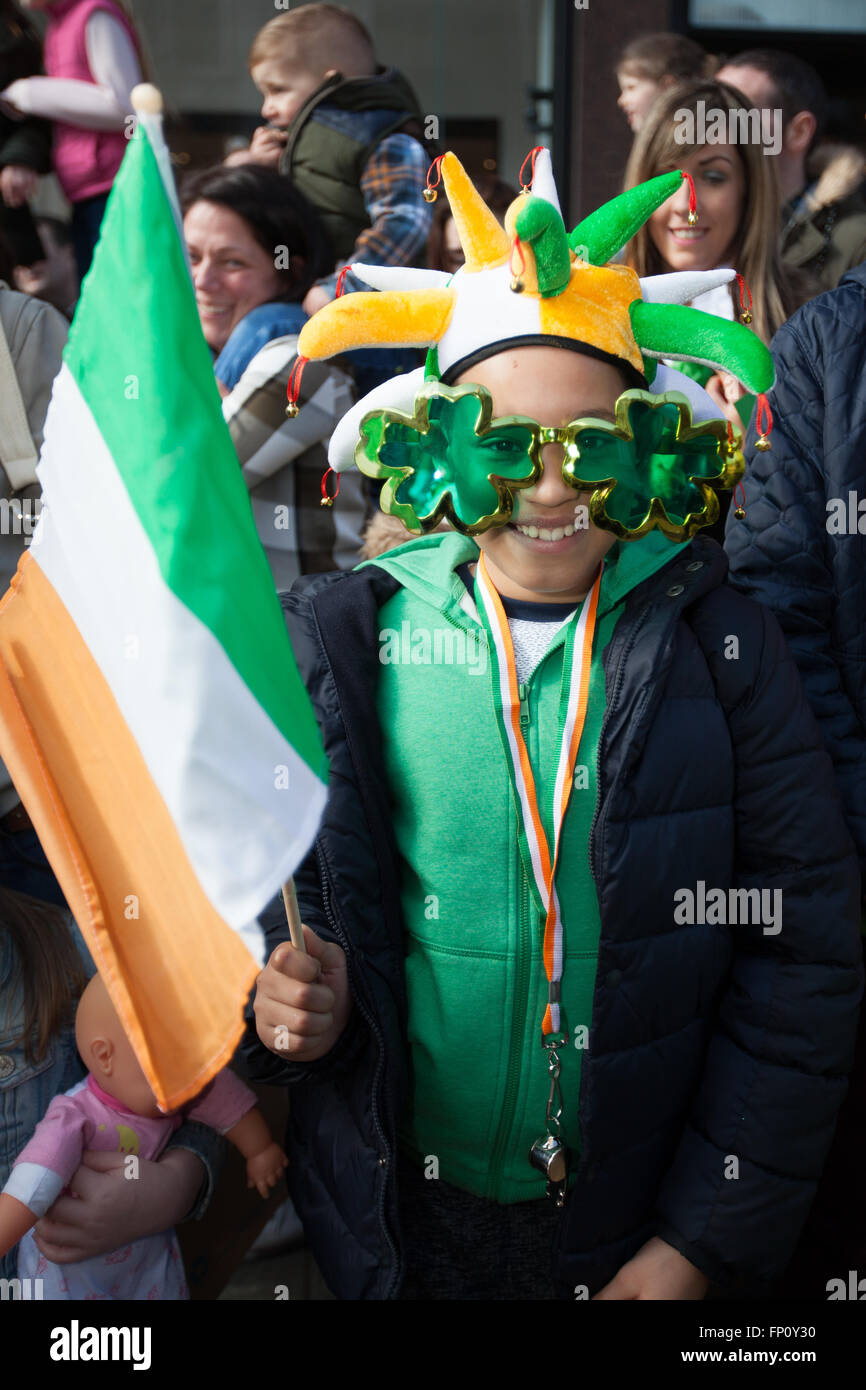 Belfast, Ireland 17th March. A girl wearing a Green white and orange ...