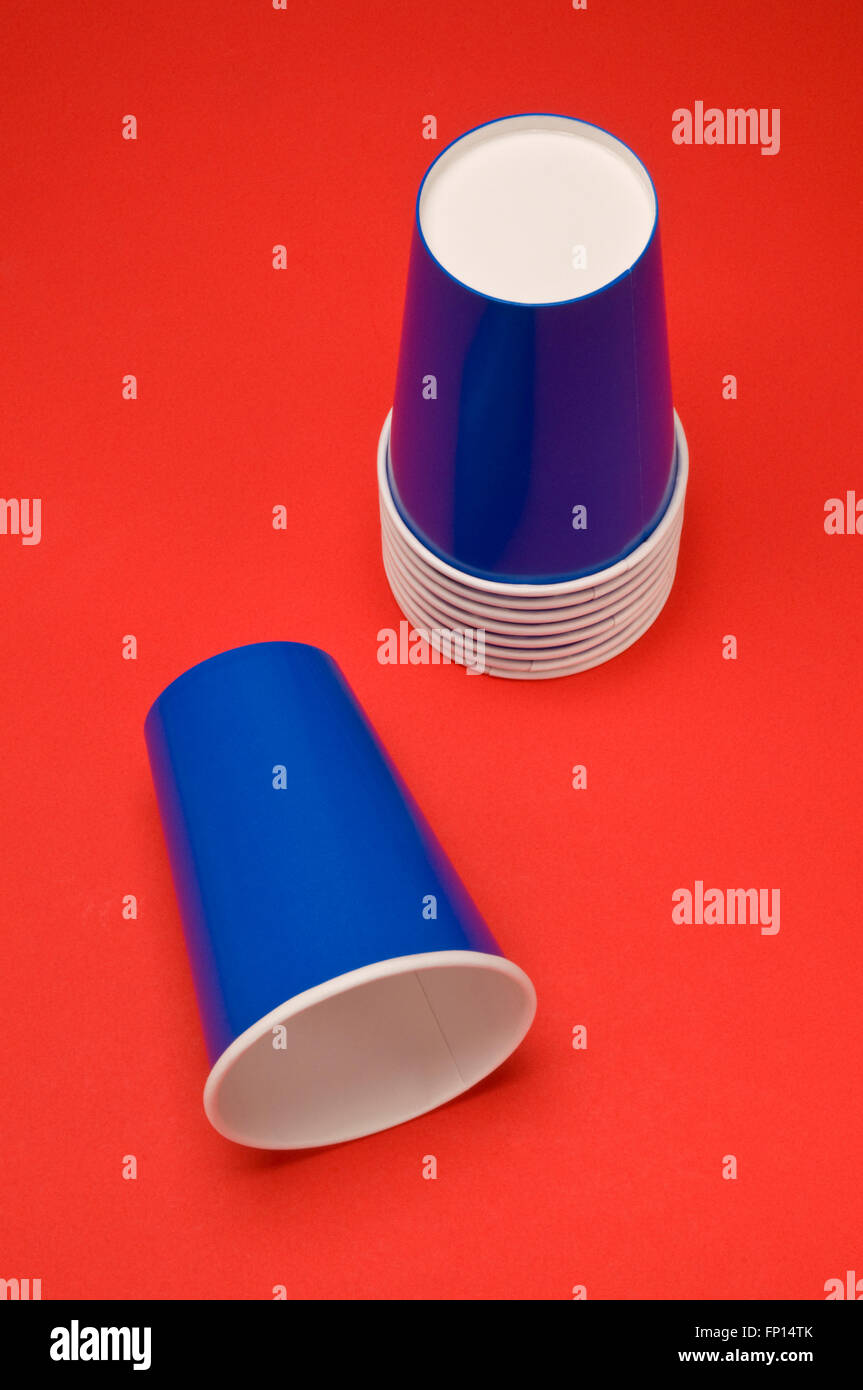 Blue drinking cups on red Stock Photo - Alamy