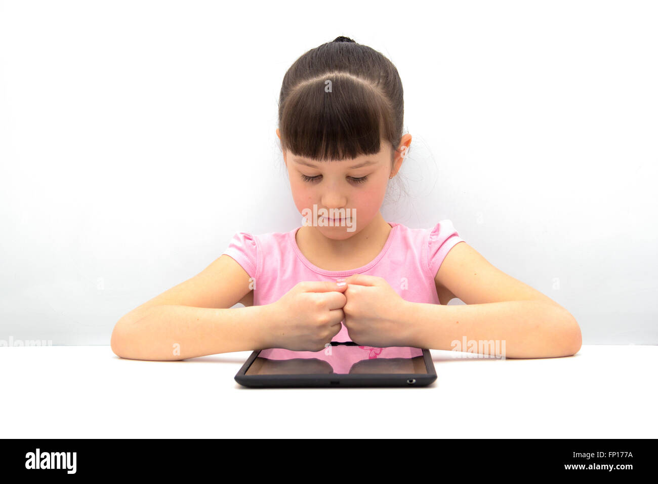 Little girl using a tablet pc Stock Photo - Alamy