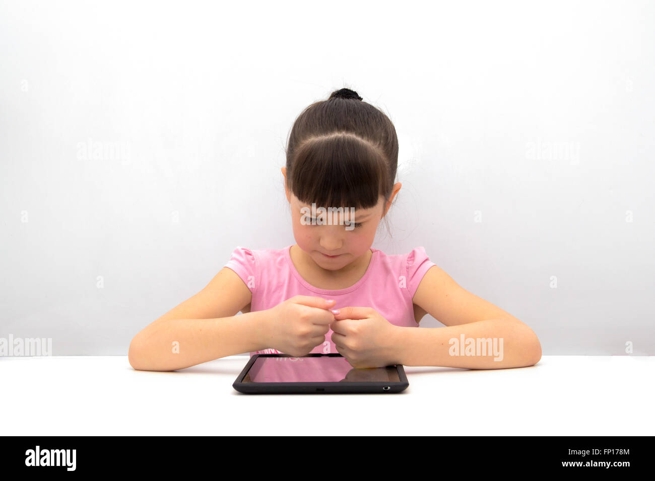 Little girl using a tablet pc Stock Photo - Alamy