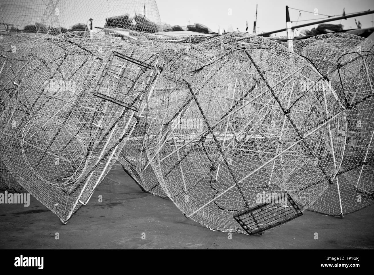 Metal fishing nets in a port. Horizontal bw toned shot Stock Photo - Alamy