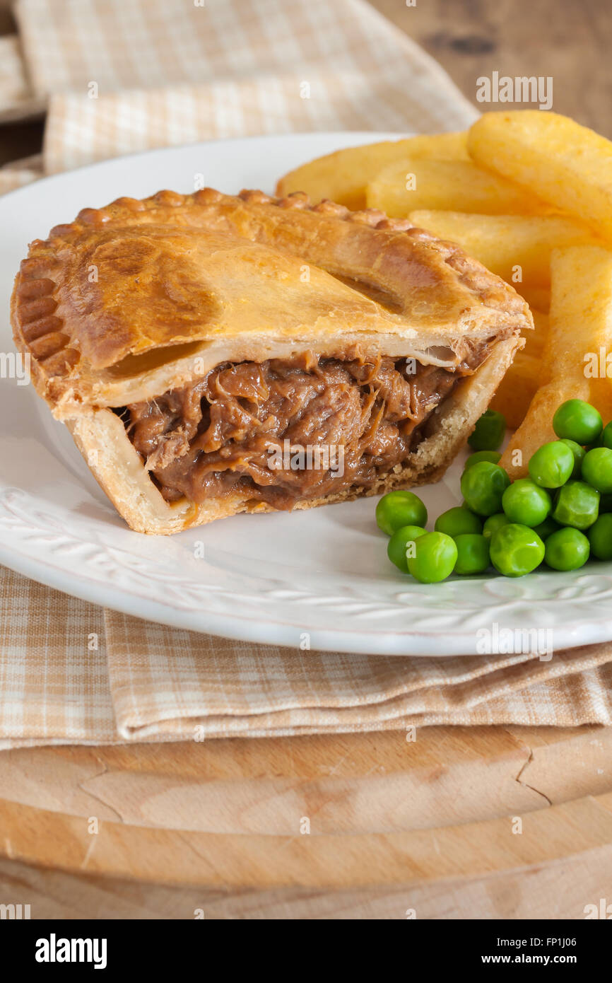 Steak or beef pie with chips or fries and green peas Stock Photo - Alamy