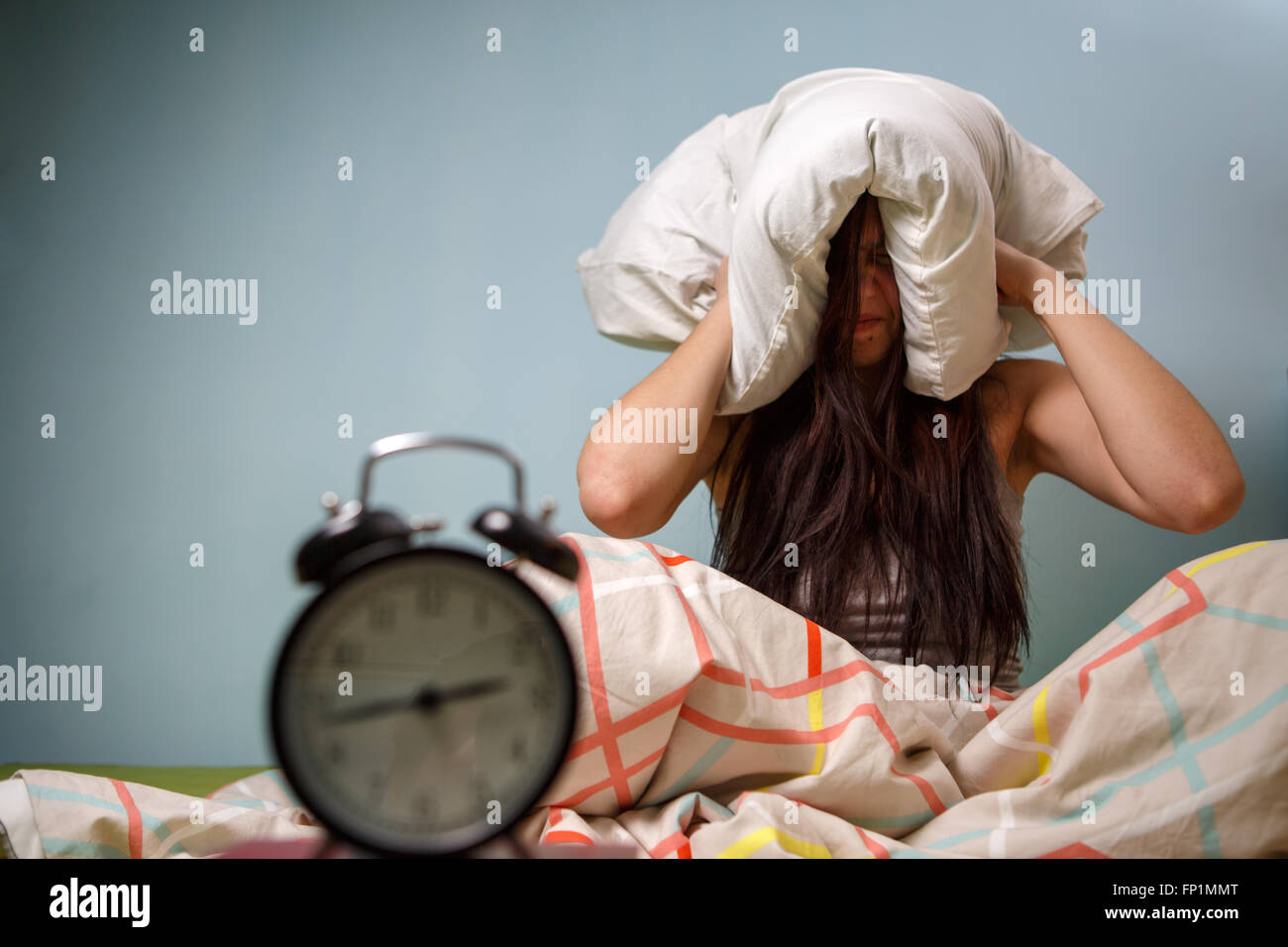 Woman with a pillow over head Stock Photo - Alamy