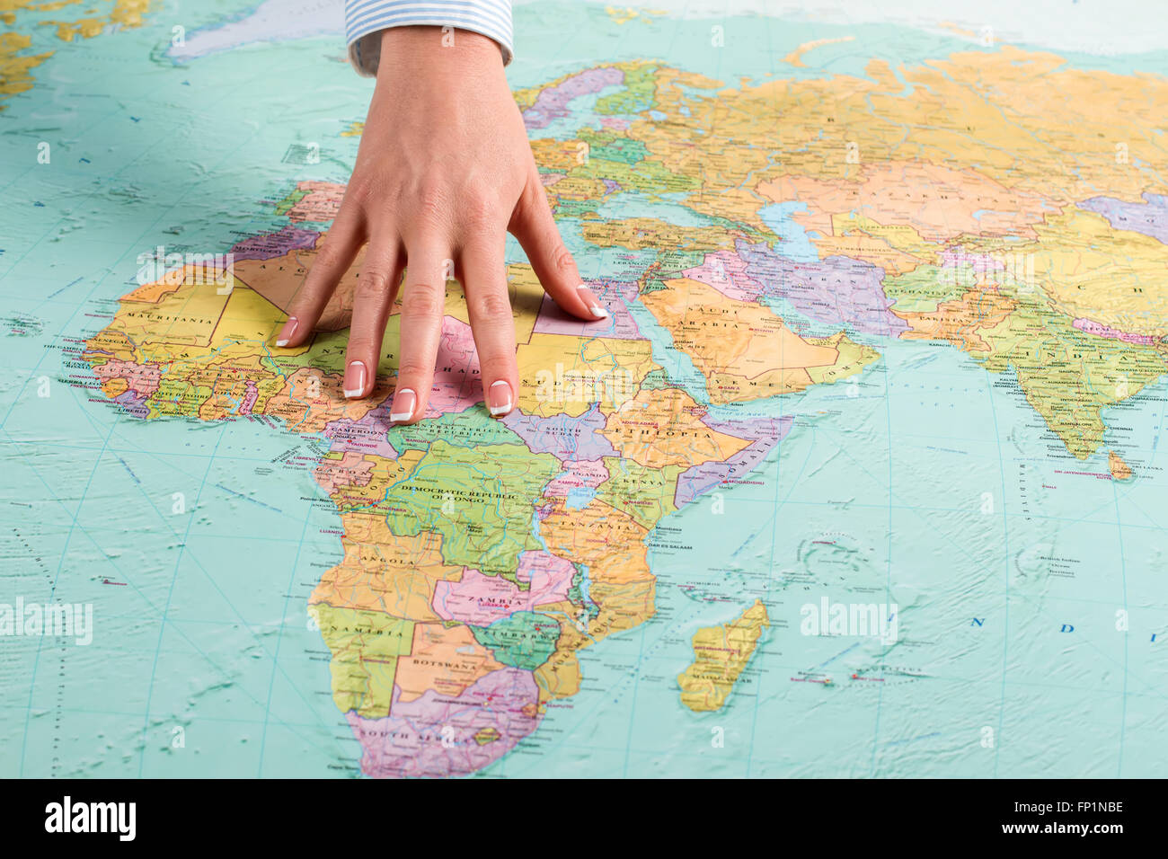 African continent on world map. Female hand shows African continent ...