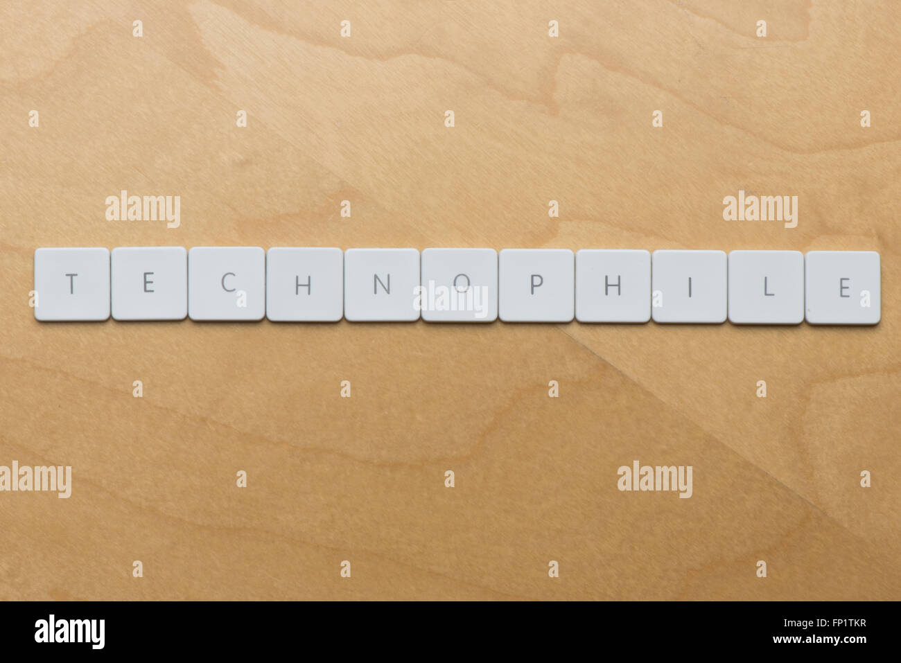 Keyboard letters spell technophile on a desk background Stock Photo - Alamy