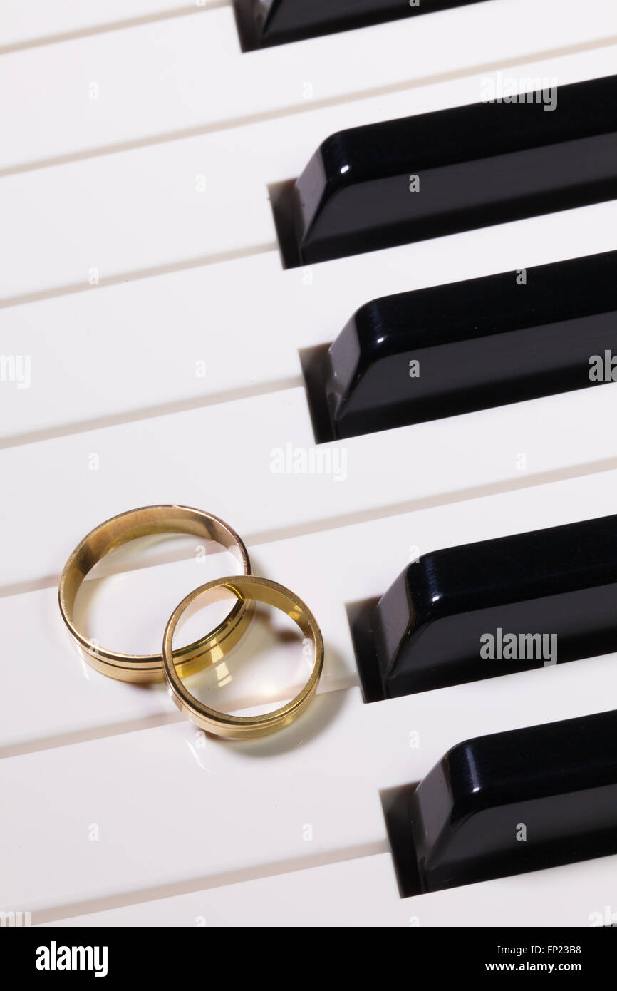 Detail of piano keyboard and wedding rings Stock Photo - Alamy