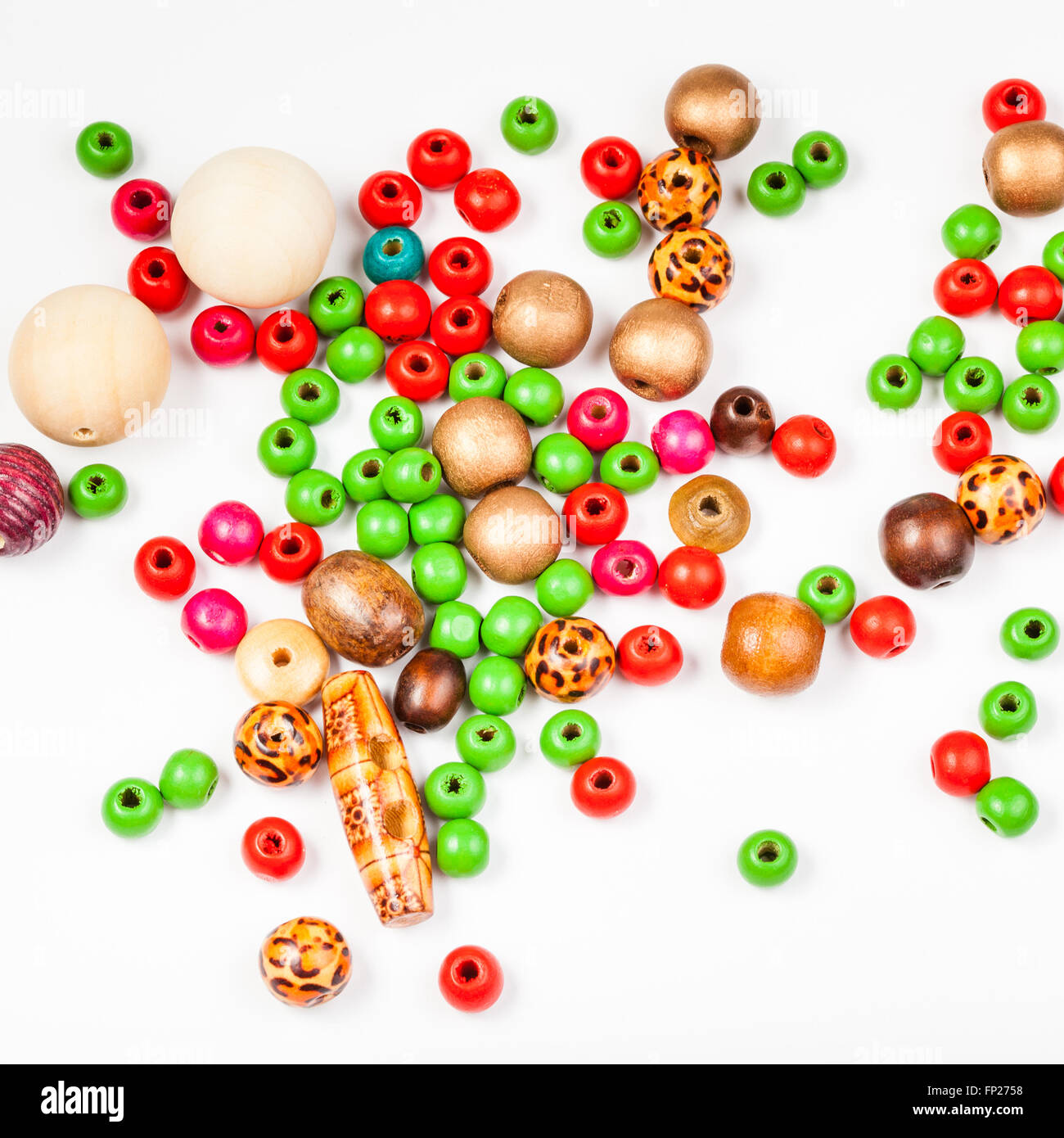 above view of many painted wooden beads on white background Stock Photo ...