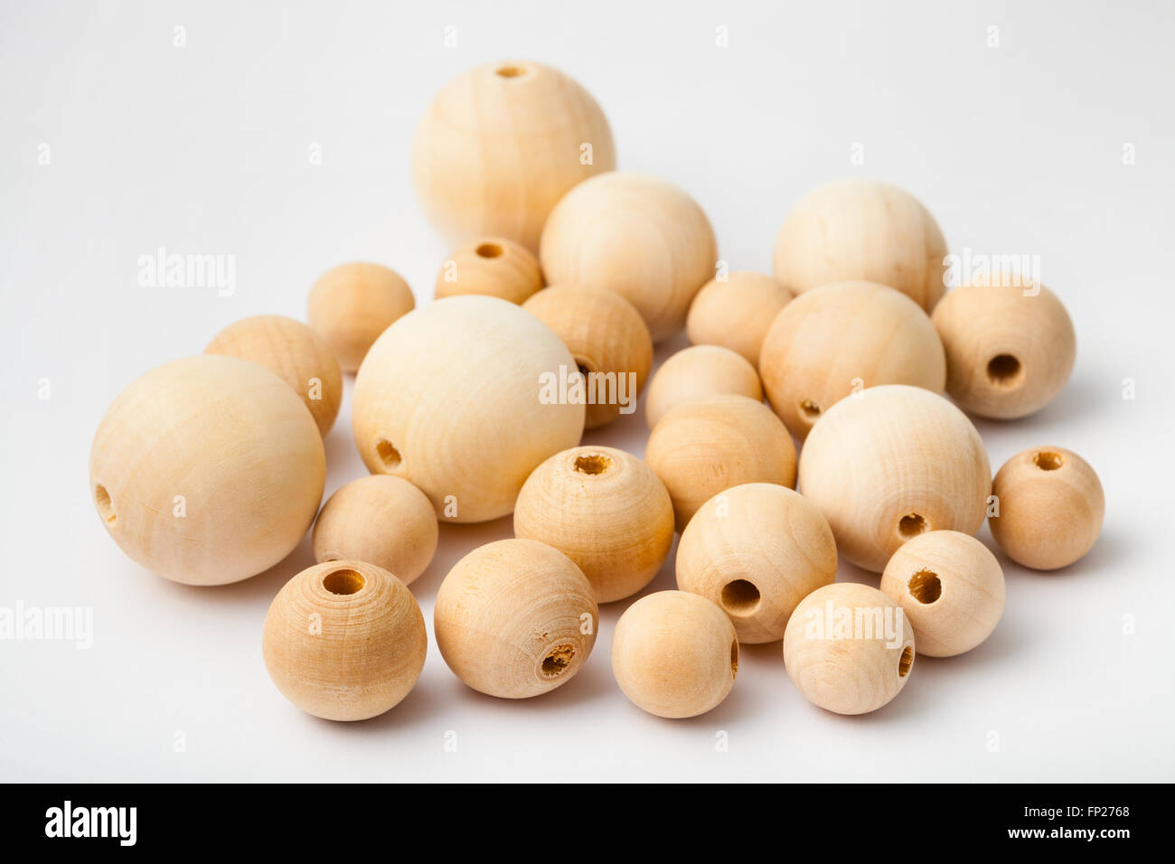 several natural wooden beads on white background Stock Photo - Alamy
