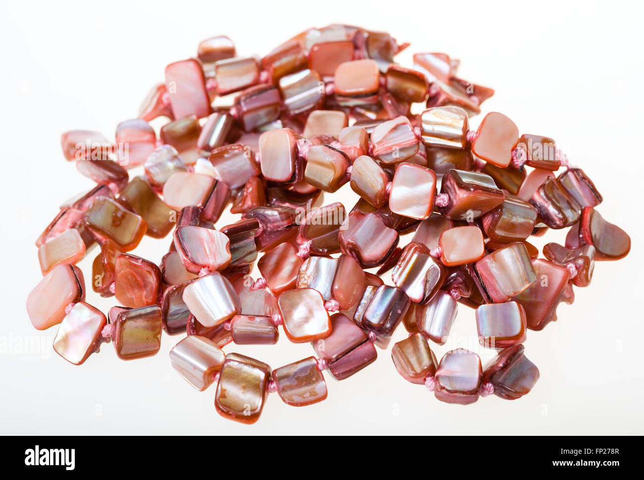 tangled necklace from pink nacre beads on white background Stock Photo ...