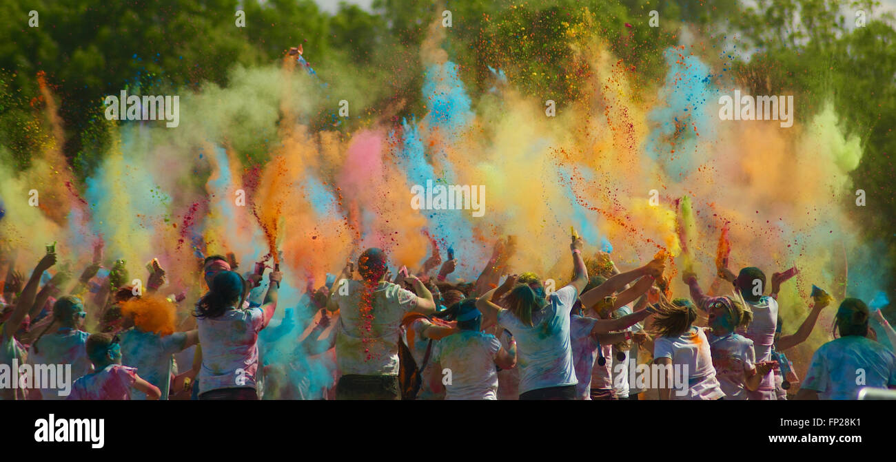 Crowd of people throwing multi-colored poster paint Stock Photo - Alamy