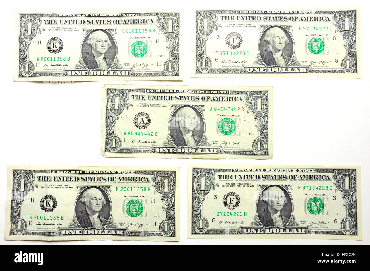 Five American One Dollar notes photographed against a white background ...