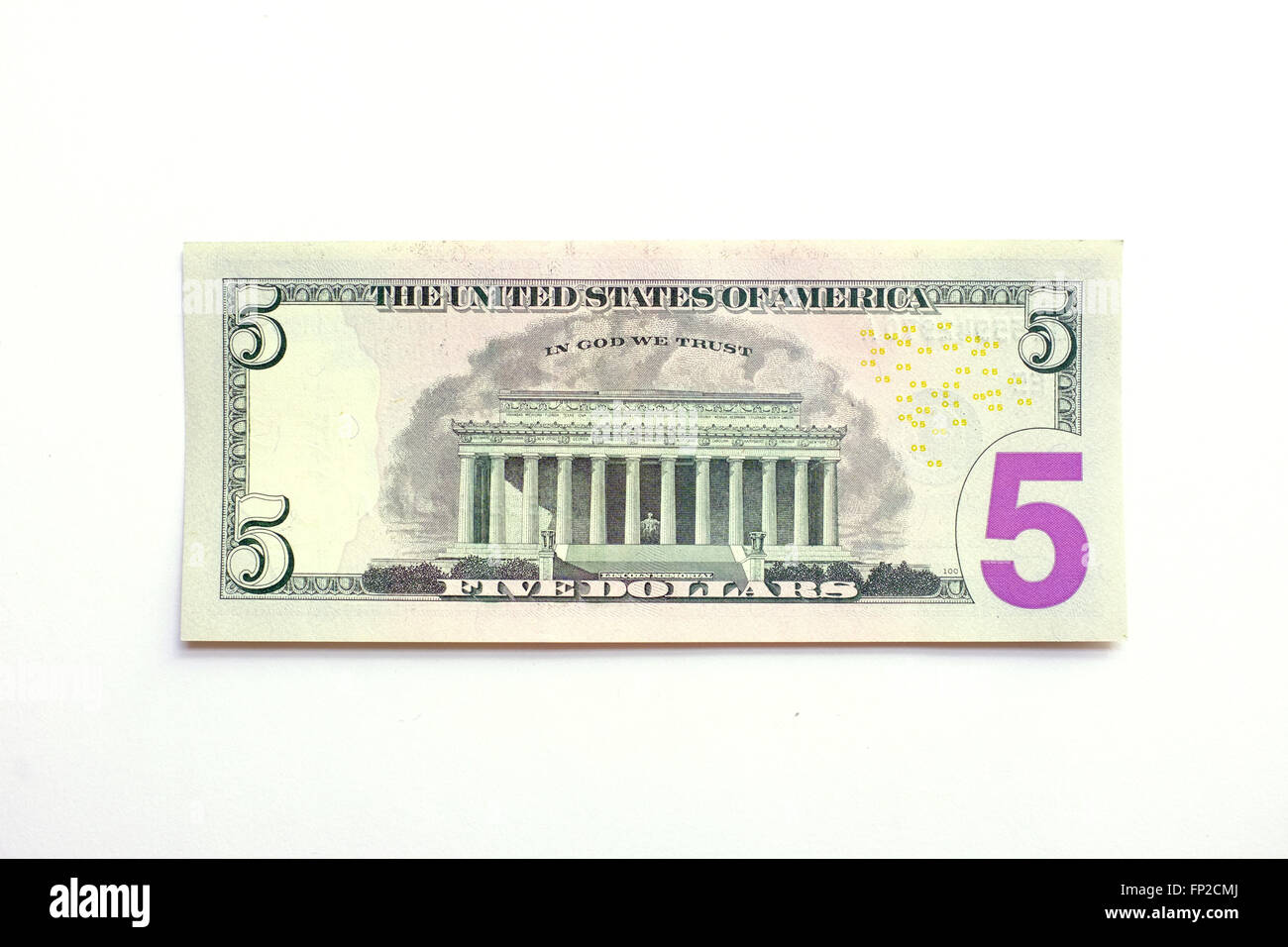 A single American Five Dollar note photographed against a white ...